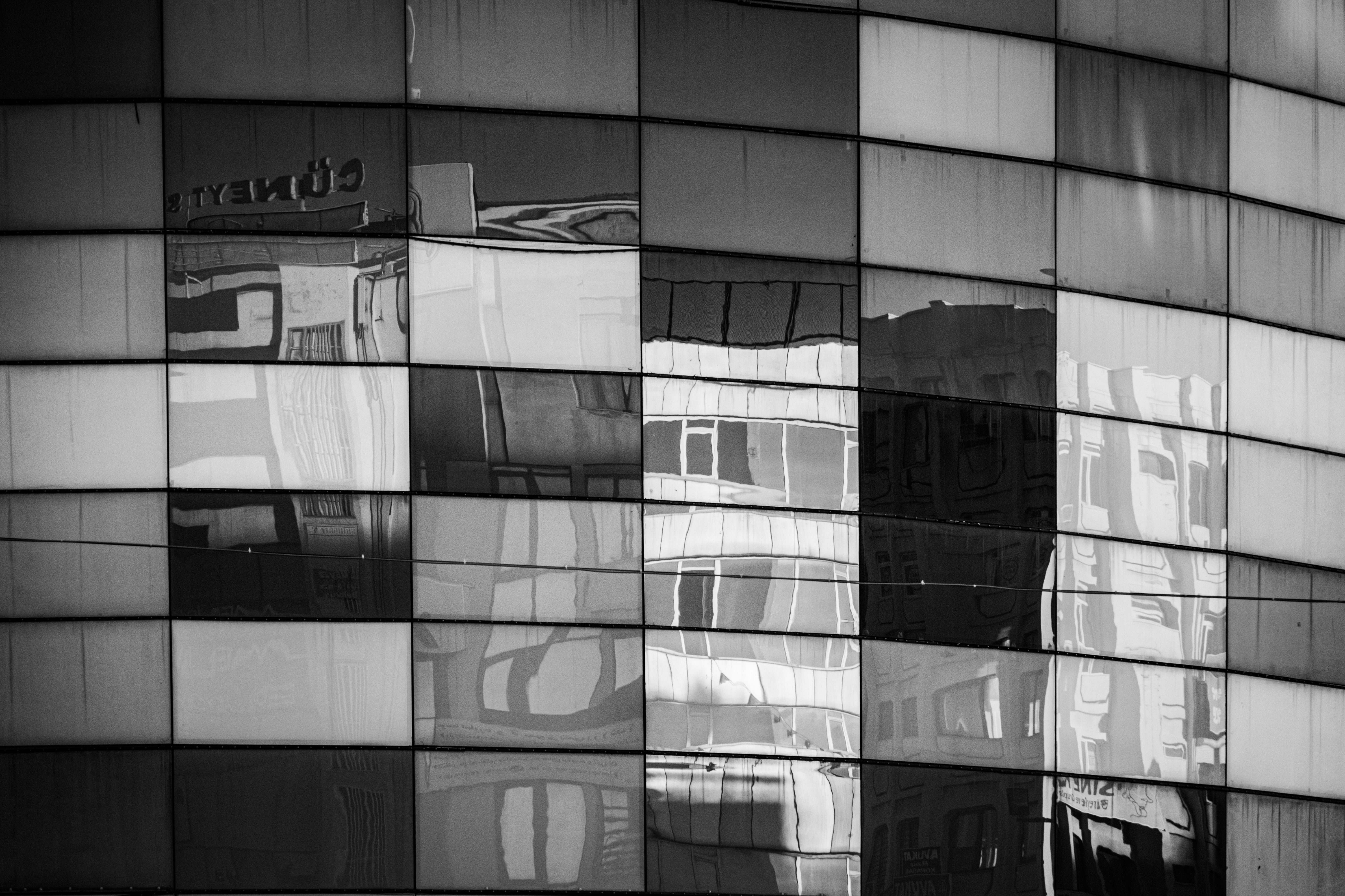 Grayscale Photo of a Building with Glass Windows · Free Stock Photo