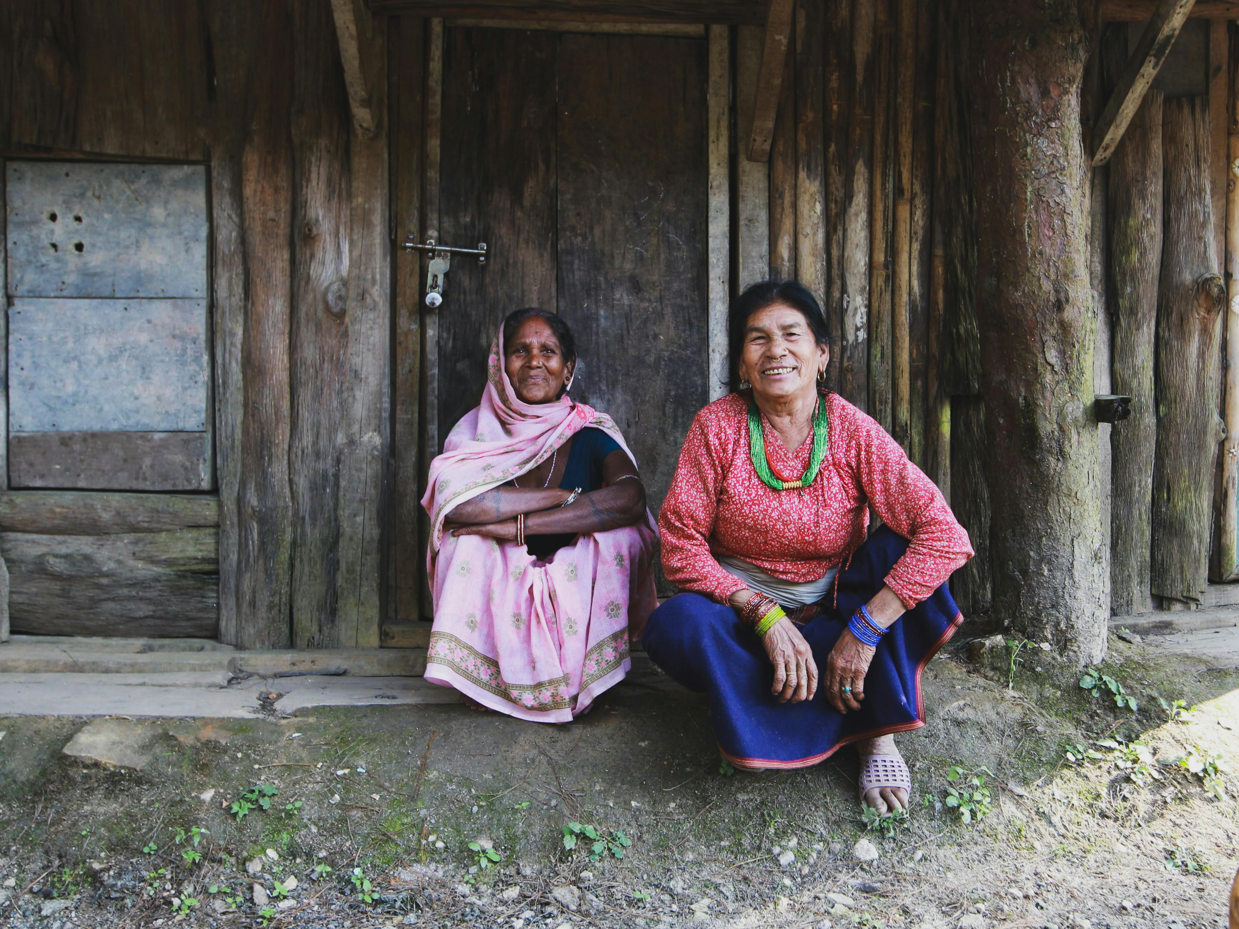 Two Village Women Sitting in Front of their House · Free Stock Photo