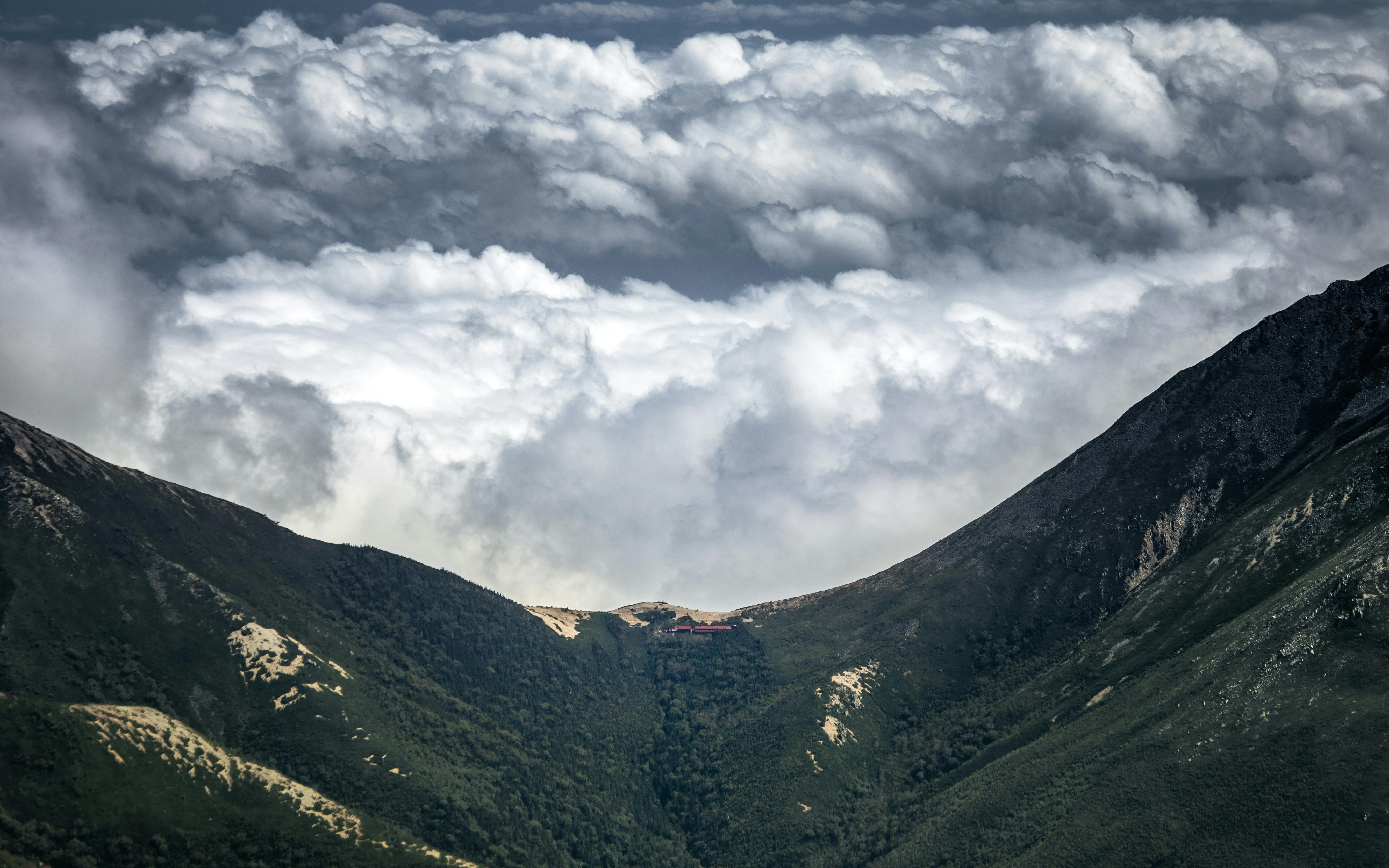 Clouds over Valley between Mountains · Free Stock Photo