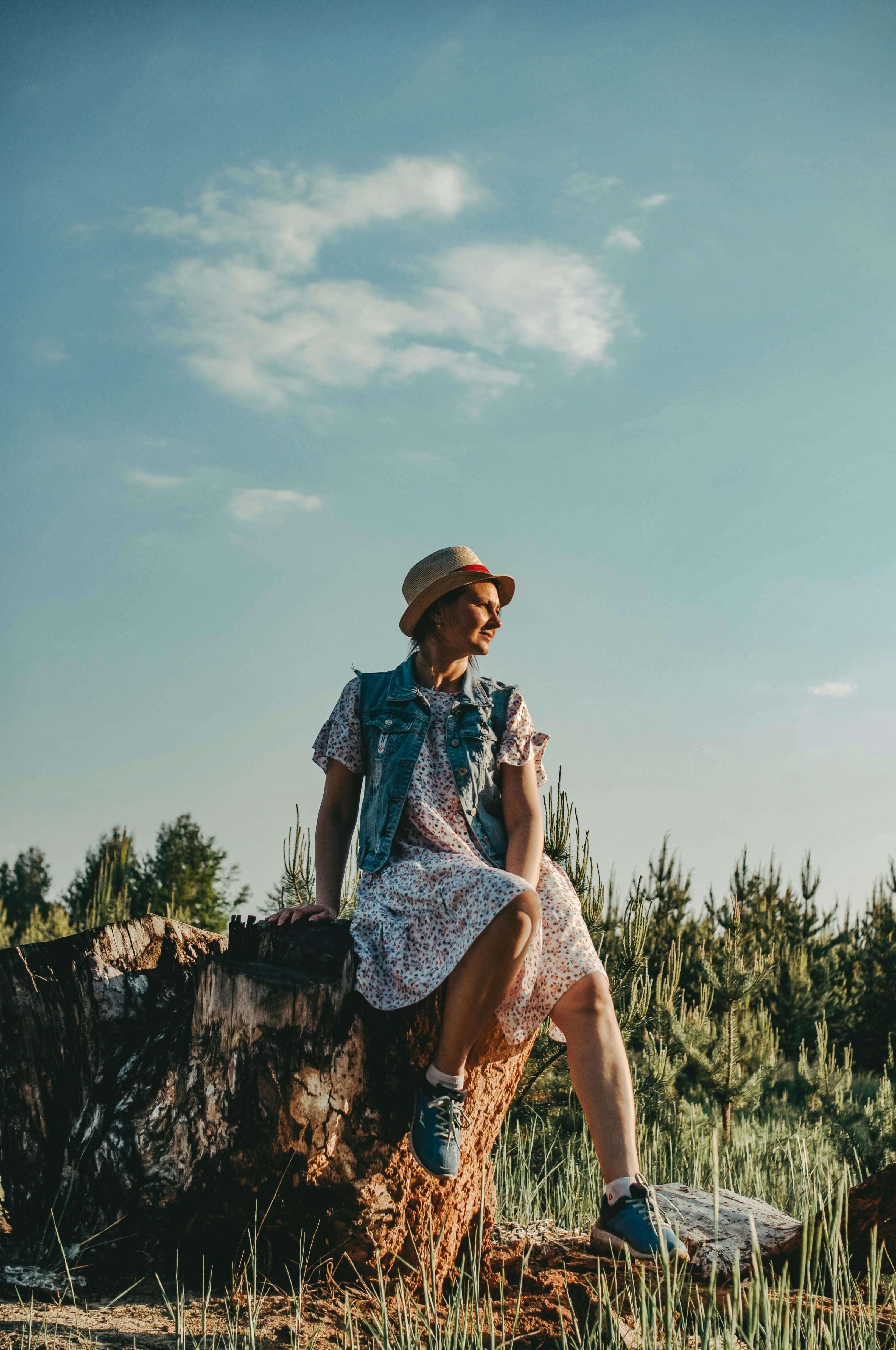 Woman Sitting on Tree Trunk · Free Stock Photo