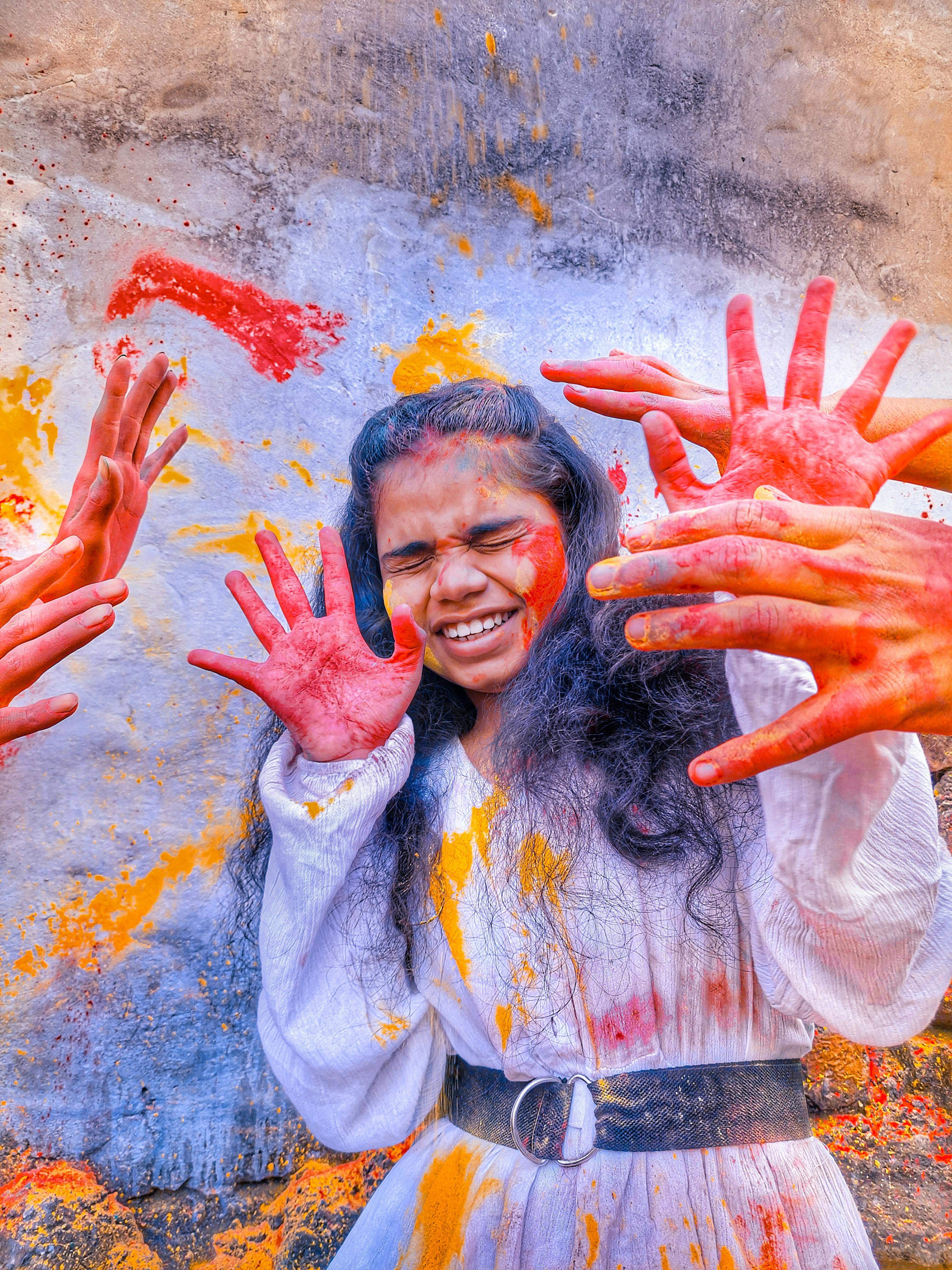 Smiling Woman Covered in Colorful Dust · Free Stock Photo
