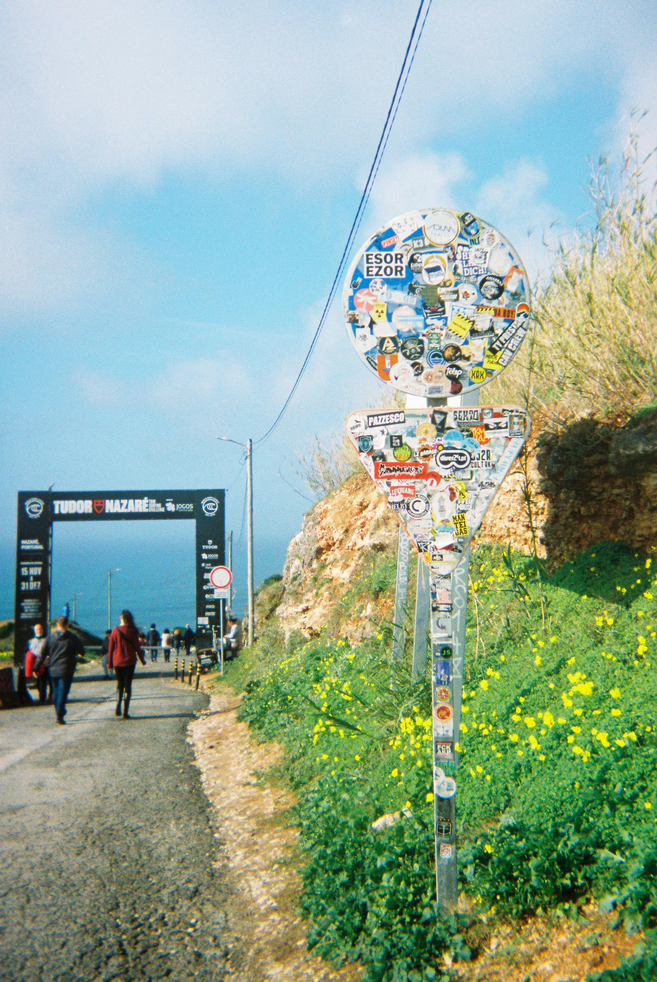 Road Signs Covered with Stickers, Nazaré, Portugal · Free Stock Photo