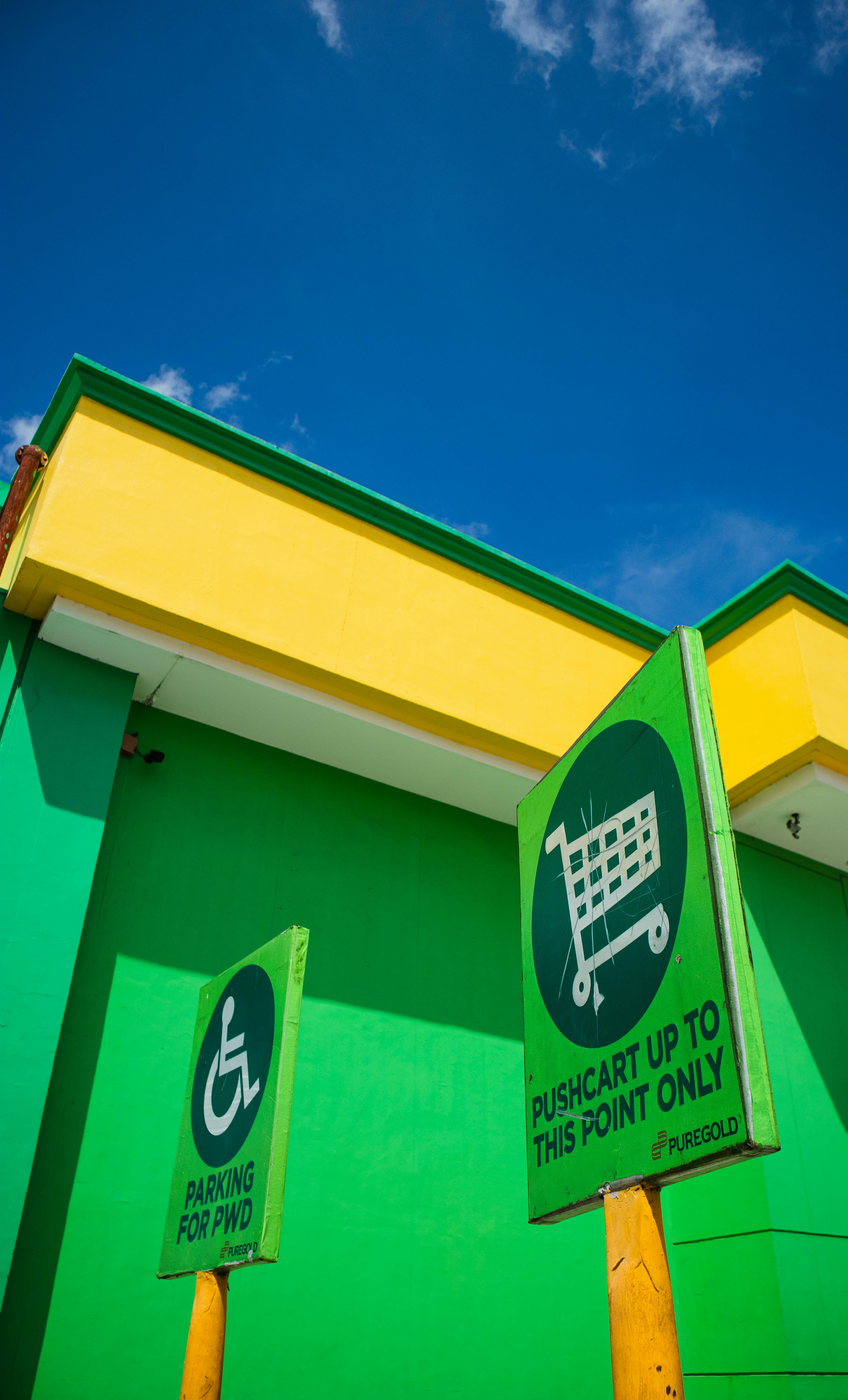 Signages of an Establishment Under Blue Sky · Free Stock Photo