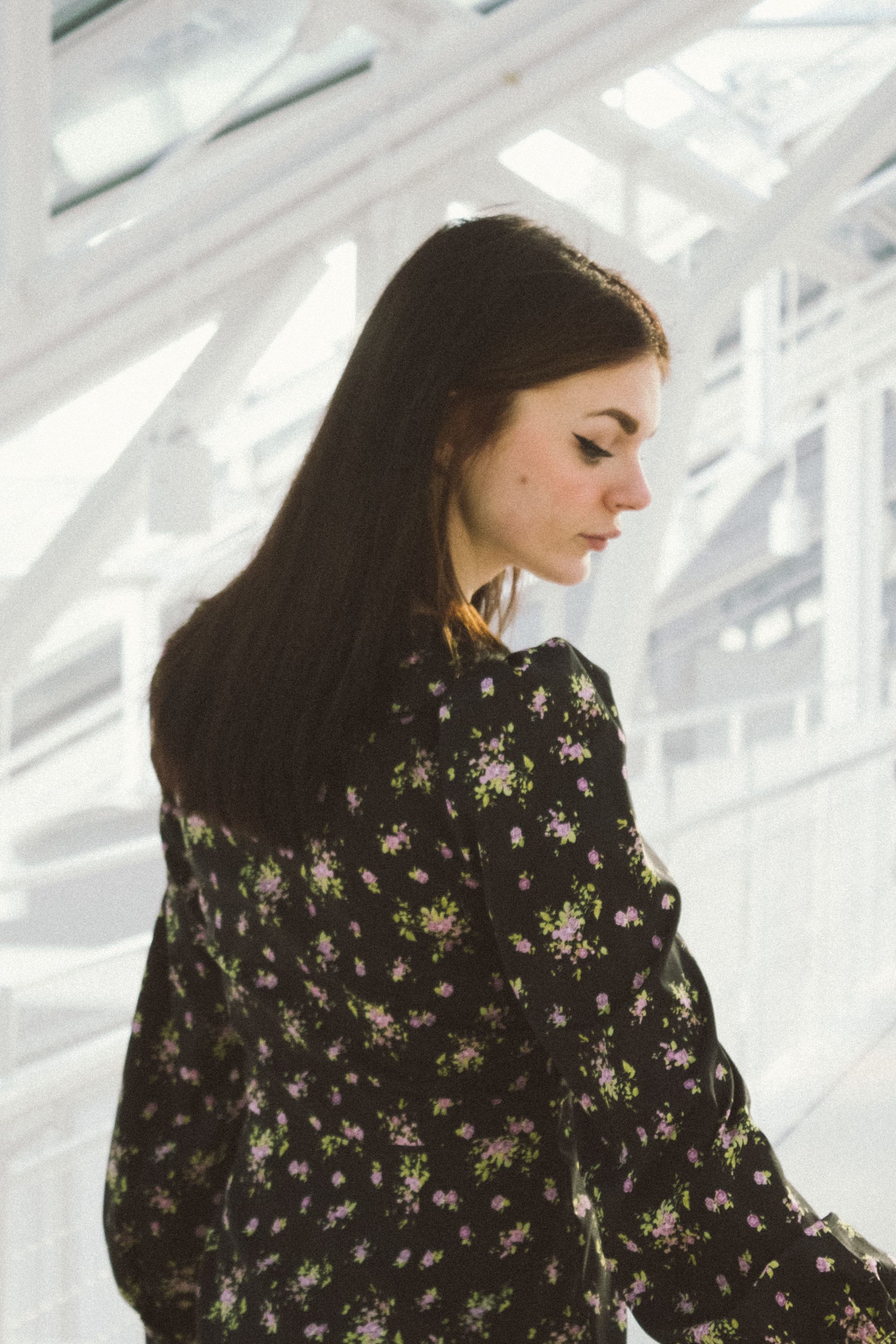 Woman in Floral Dress Parting Curtains and Going out · Free Stock Photo