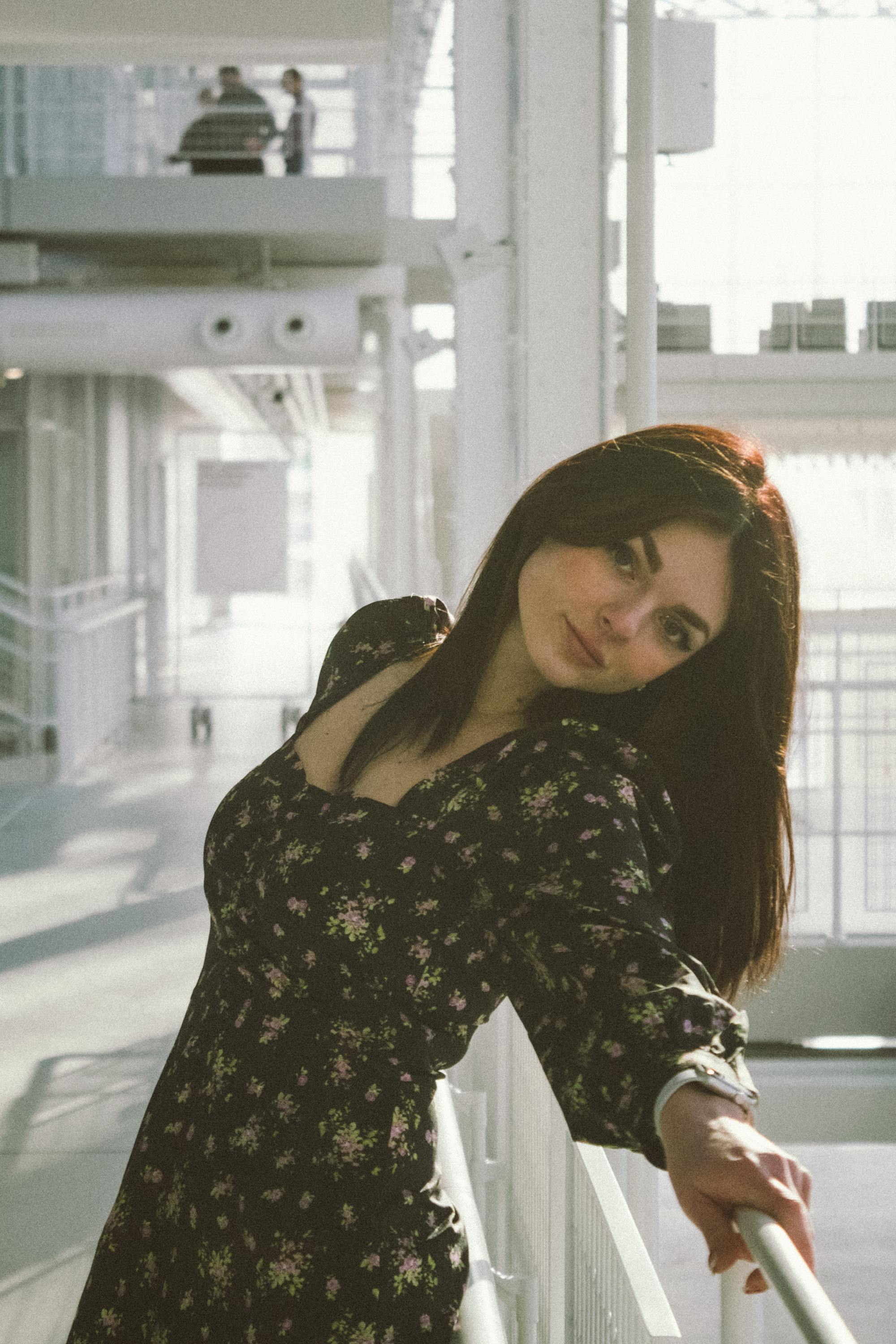 Woman Leaning Against Railing · Free Stock Photo