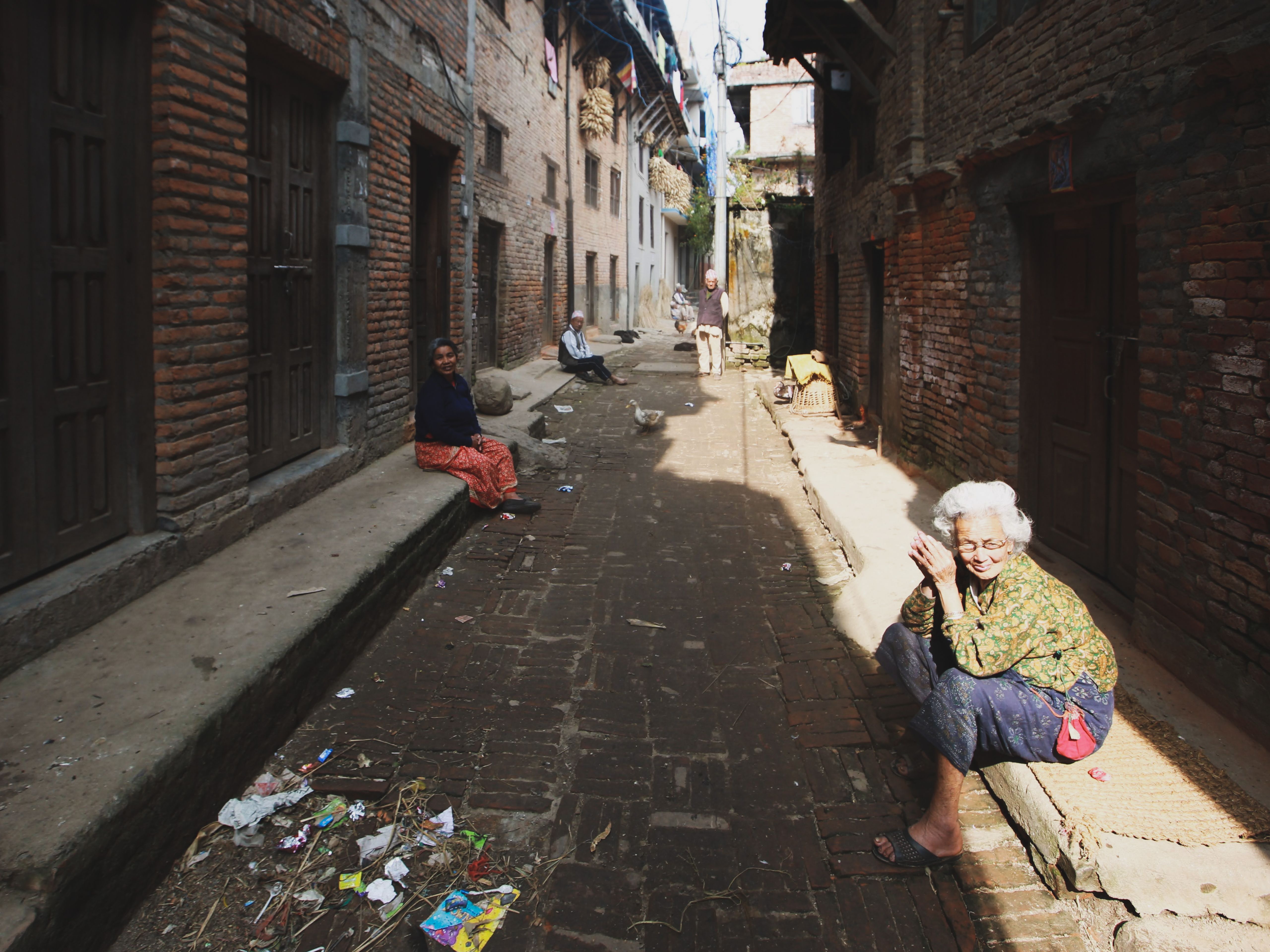 Old Women Sitting on Pavement on Street · Free Stock Photo