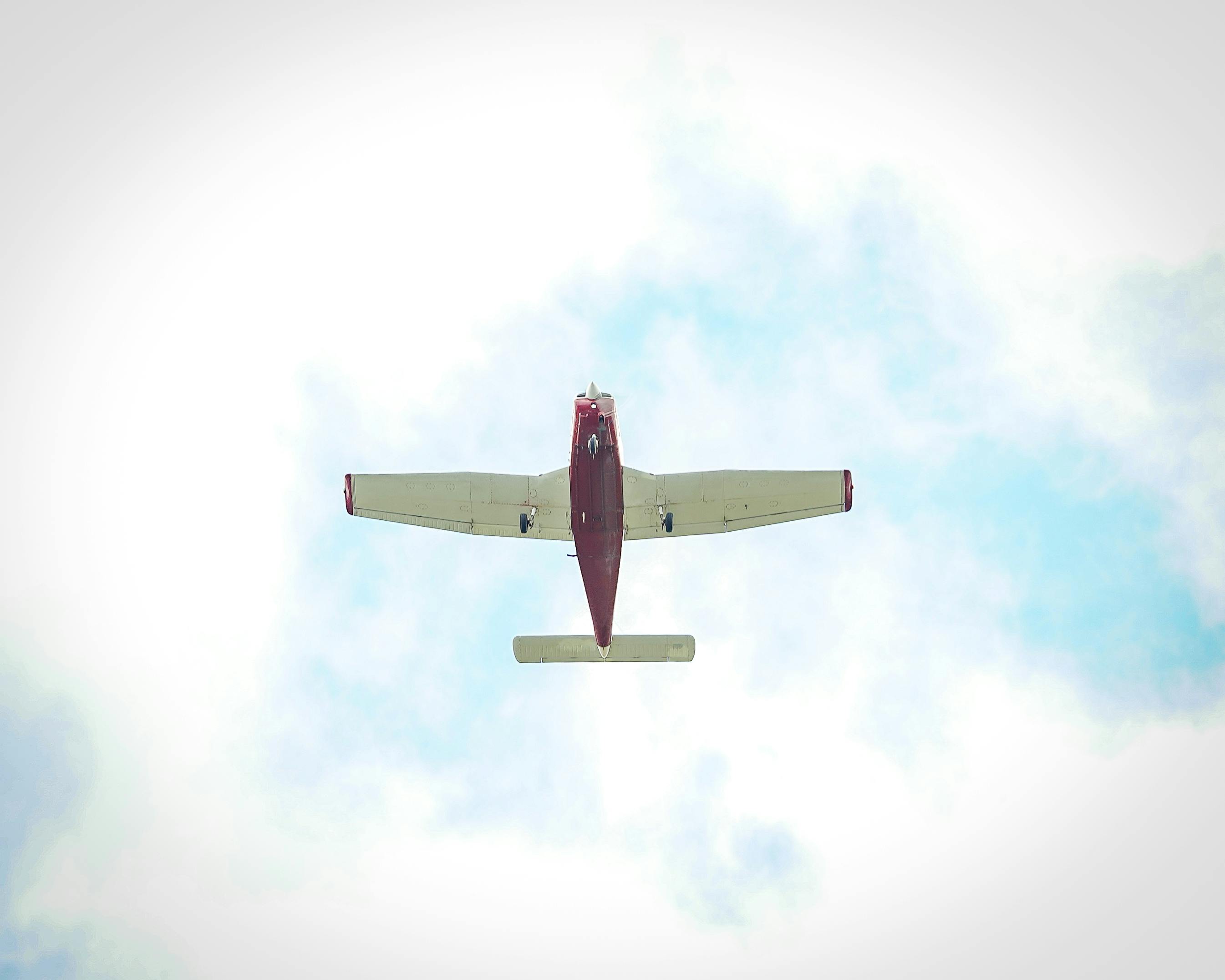 Low Angle View of a Flying Airplane · Free Stock Photo