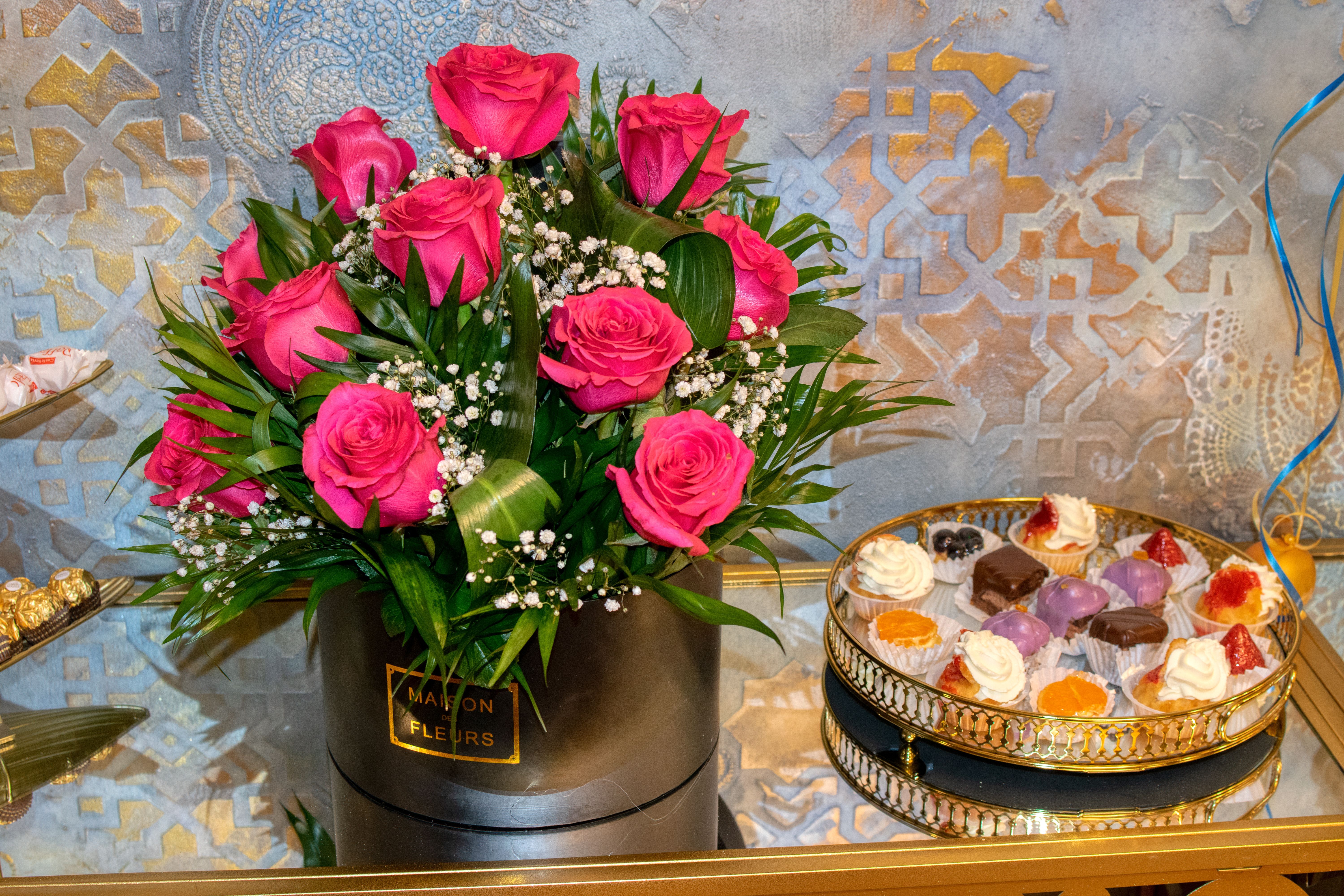 A Bouquet of Roses Near Desserts · Free Stock Photo