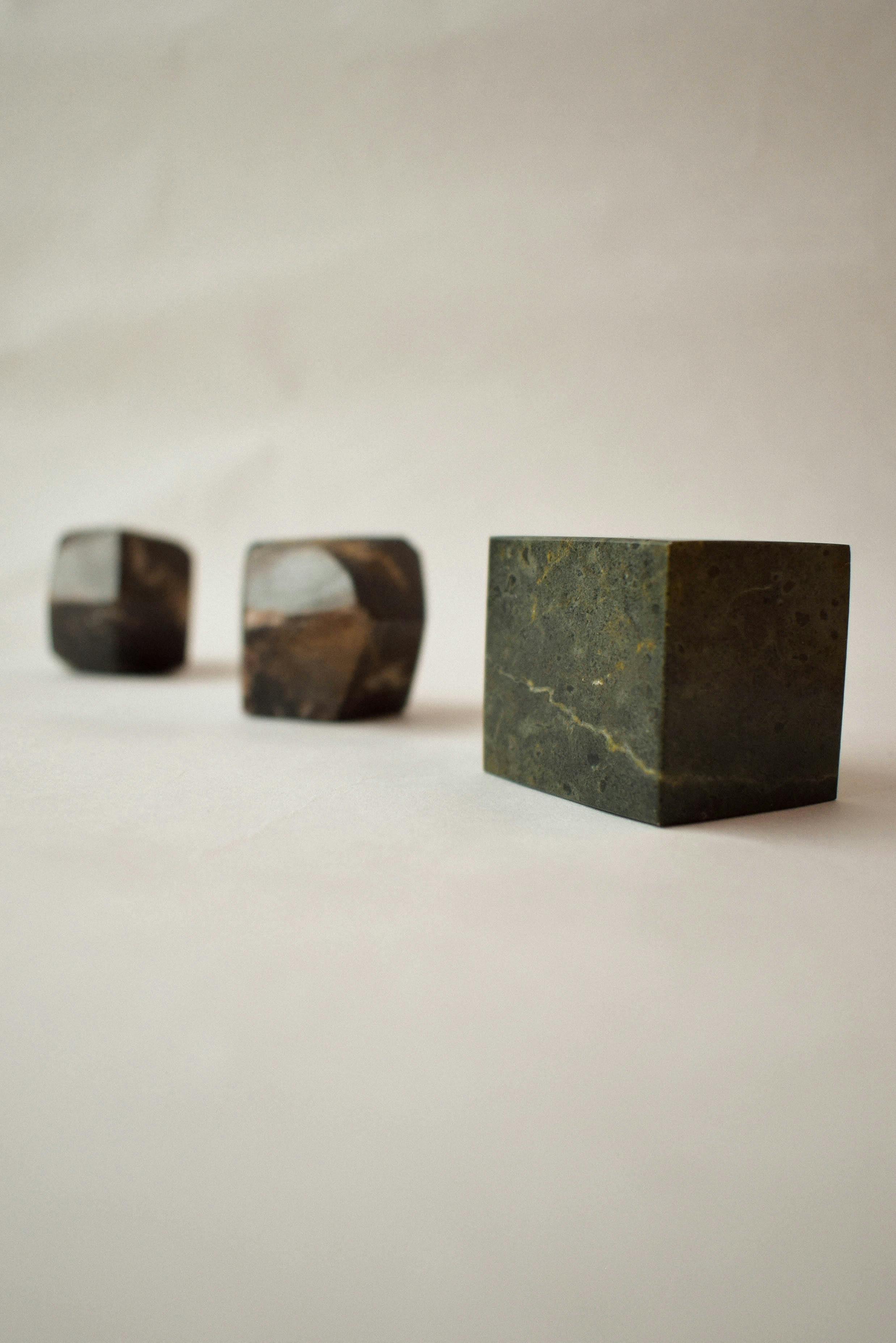 A Cube and Rocks on a White Background · Free Stock Photo