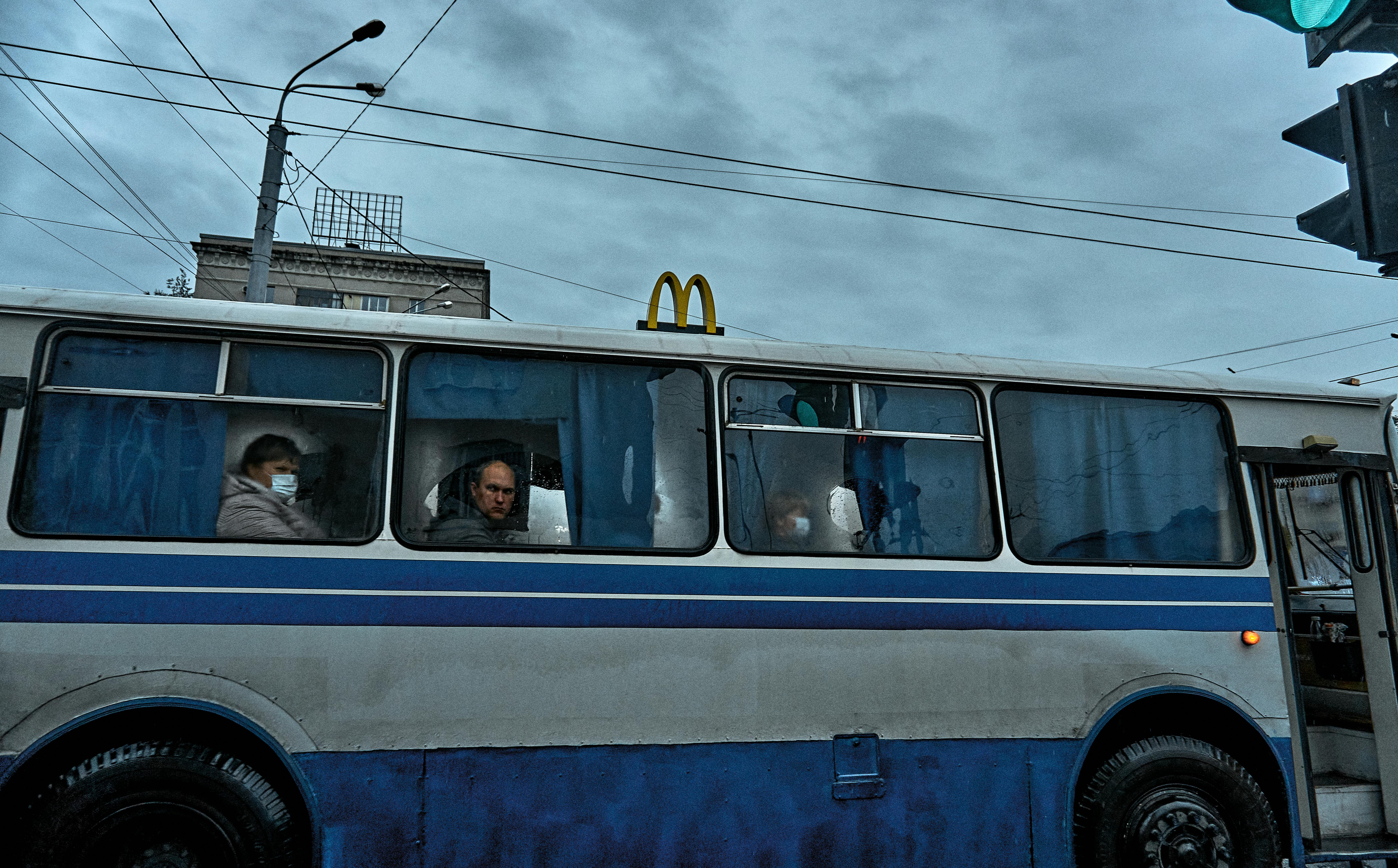 People Sitting on a Bus under a Gloomy Sky · Free Stock Photo