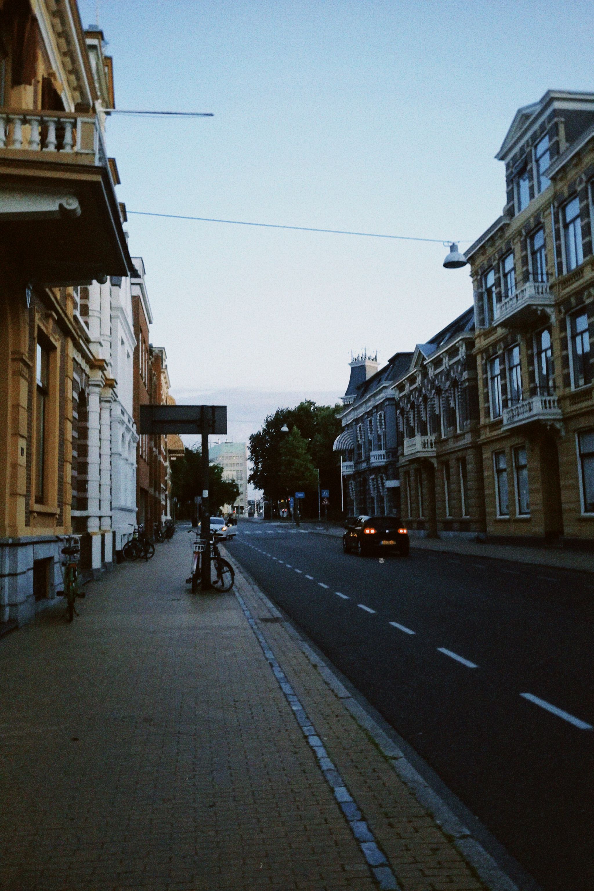 People Walking on Sidewalk Between Buildings · Free Stock Photo
