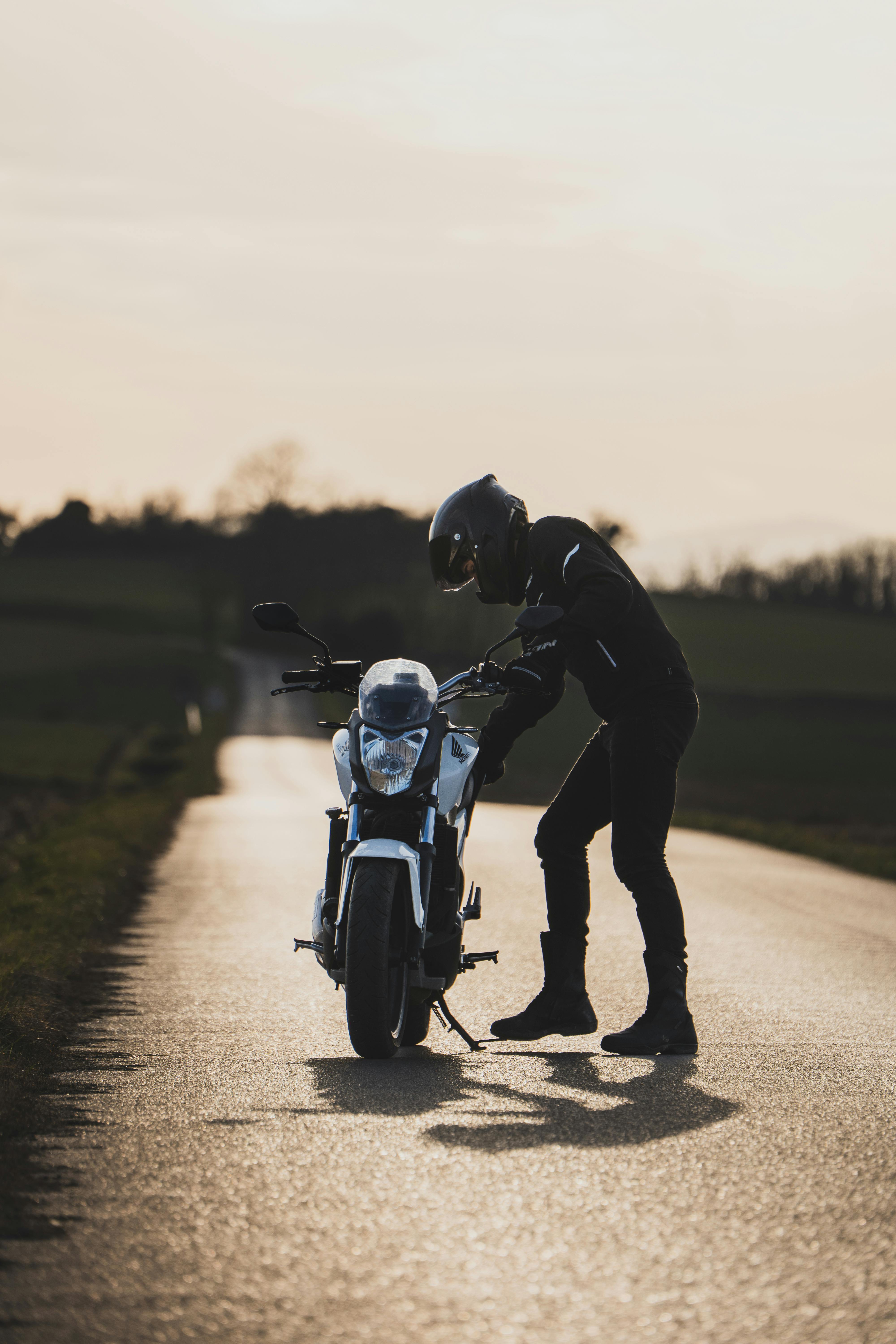 Person Riding Motorcycle during Golden Hour · Free Stock Photo