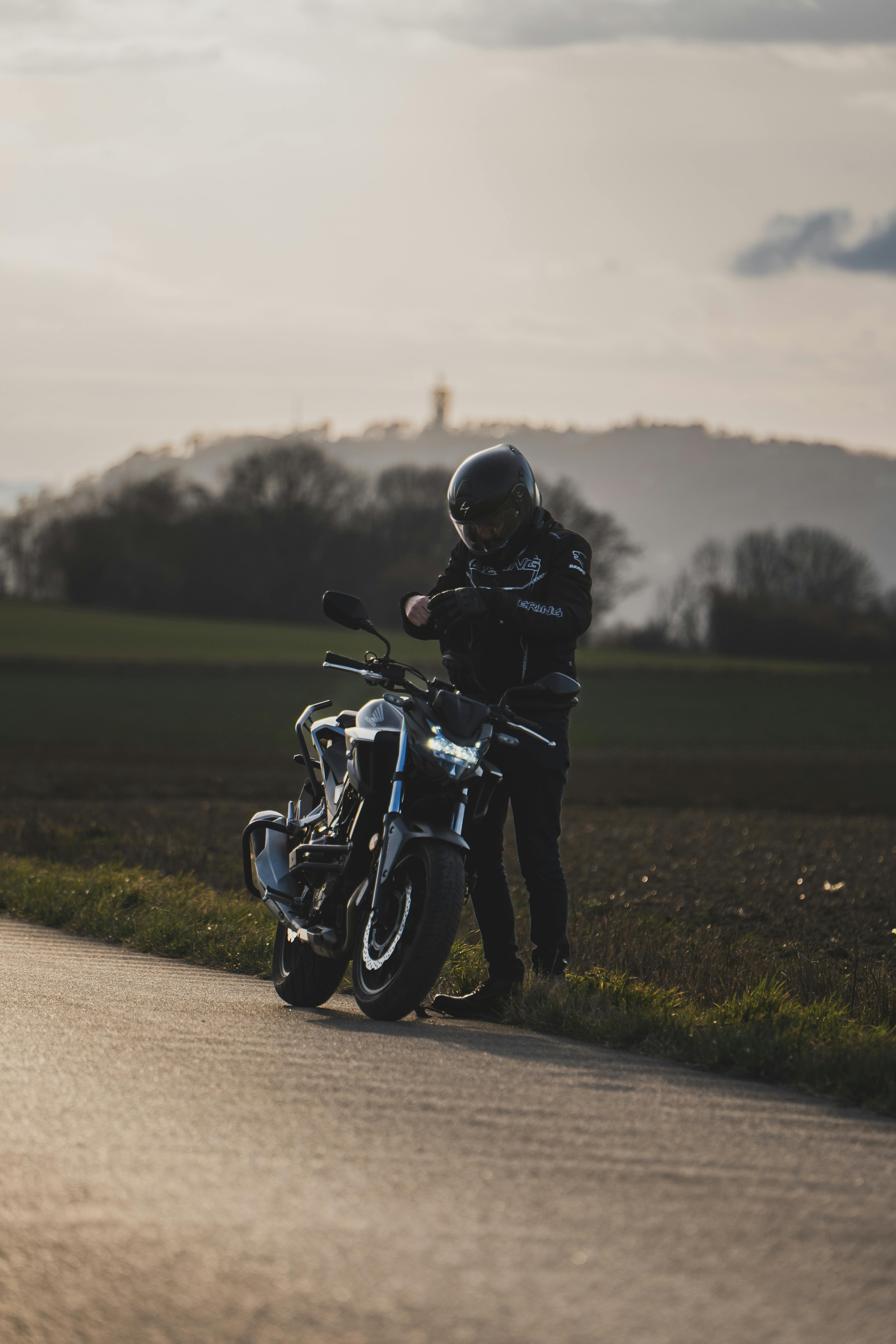 A Woman Wearing a White Crop Top Riding a Motorcycle · Free Stock Photo