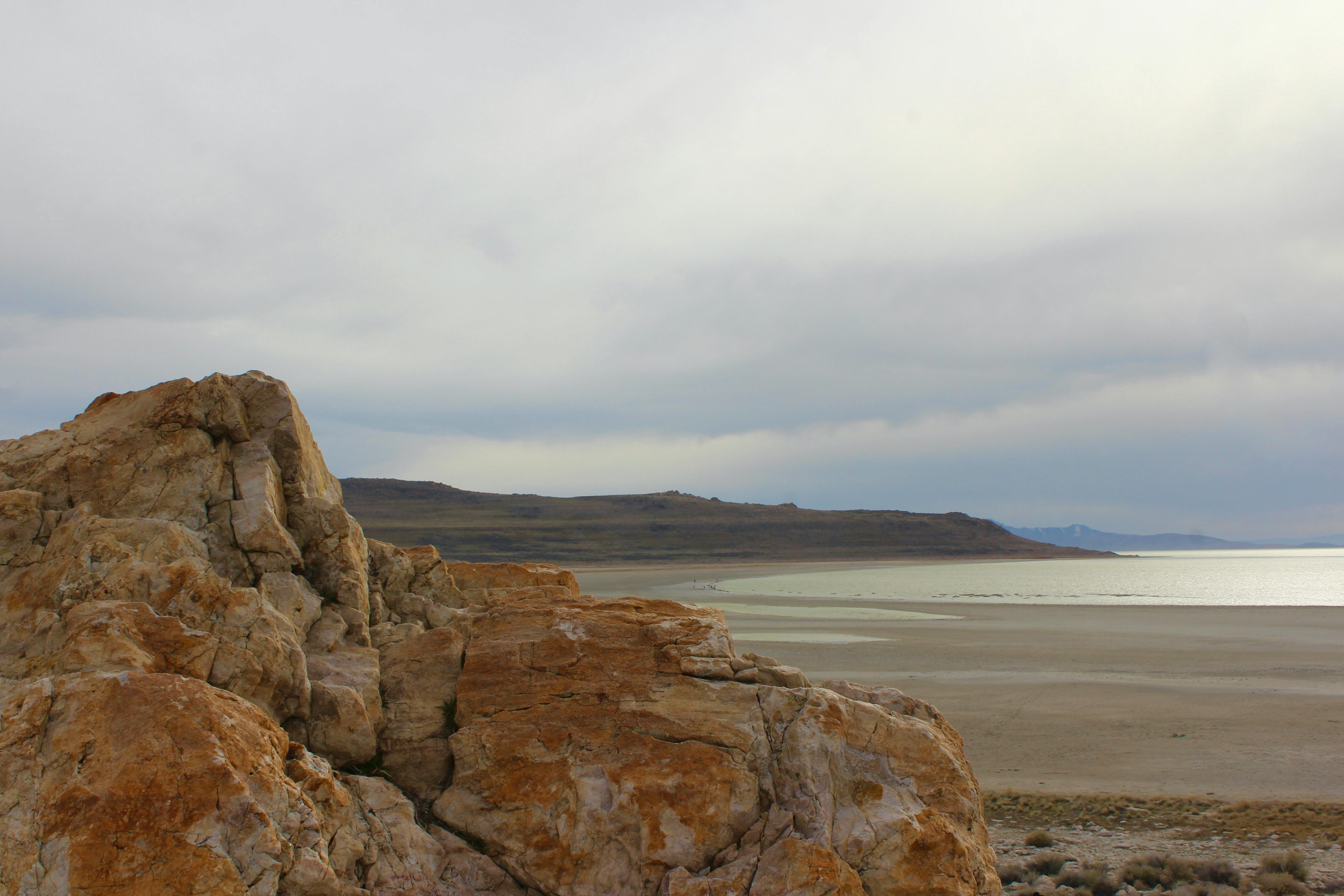 Rock near Beach under Clouds · Free Stock Photo