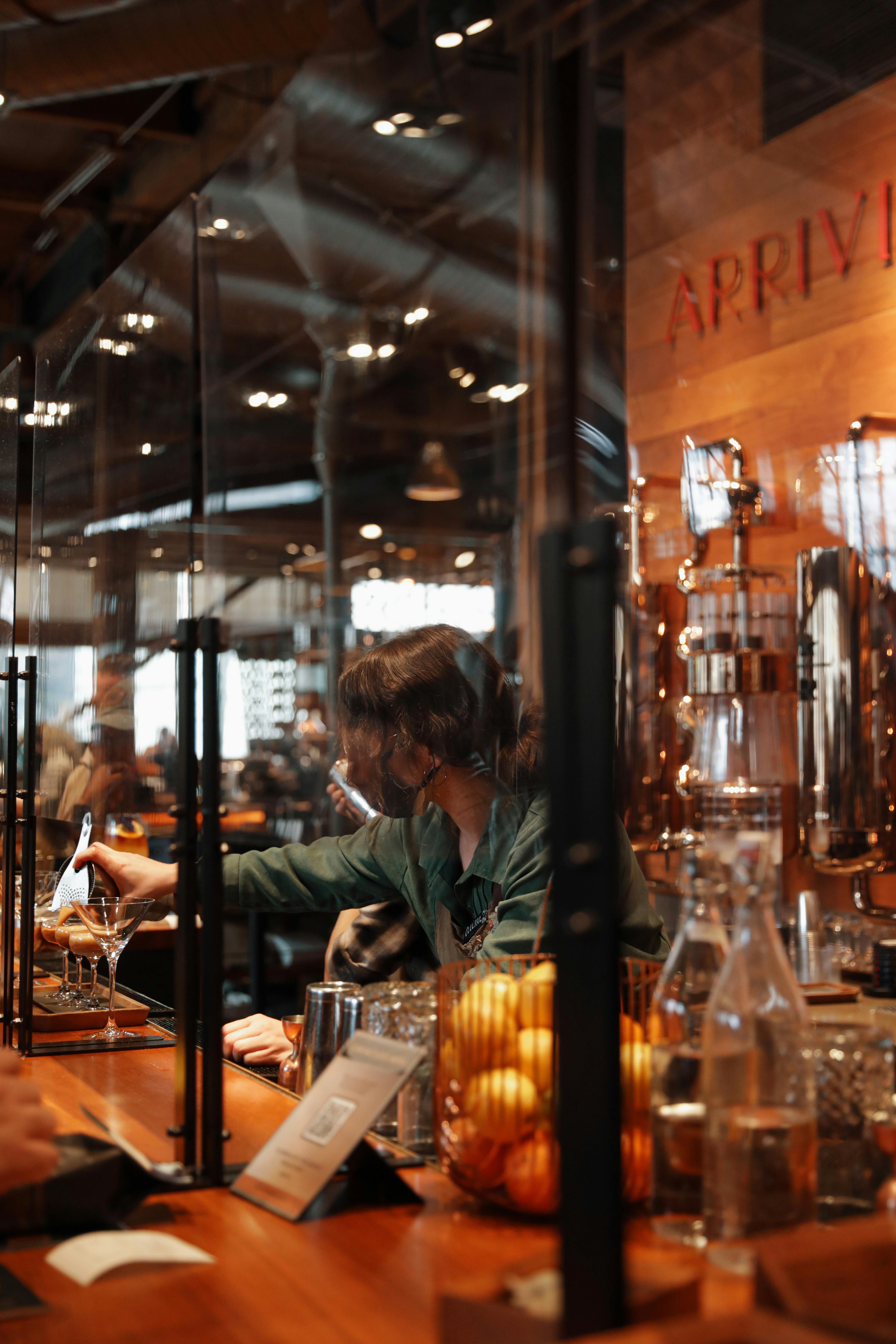 A Bartender Behind the Bar Counter · Free Stock Photo