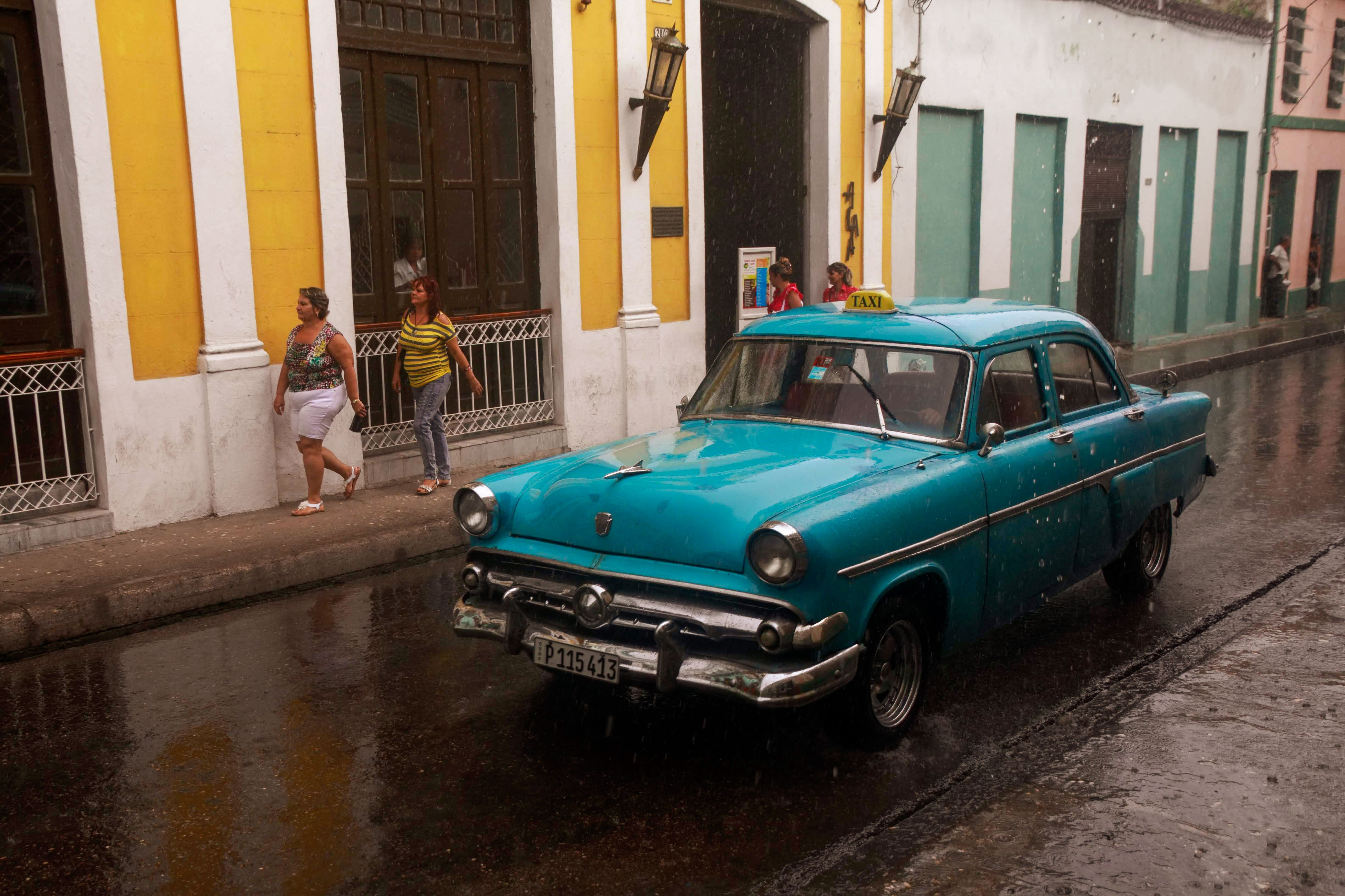 A Blue Taxi on a Rainy Day · Free Stock Photo