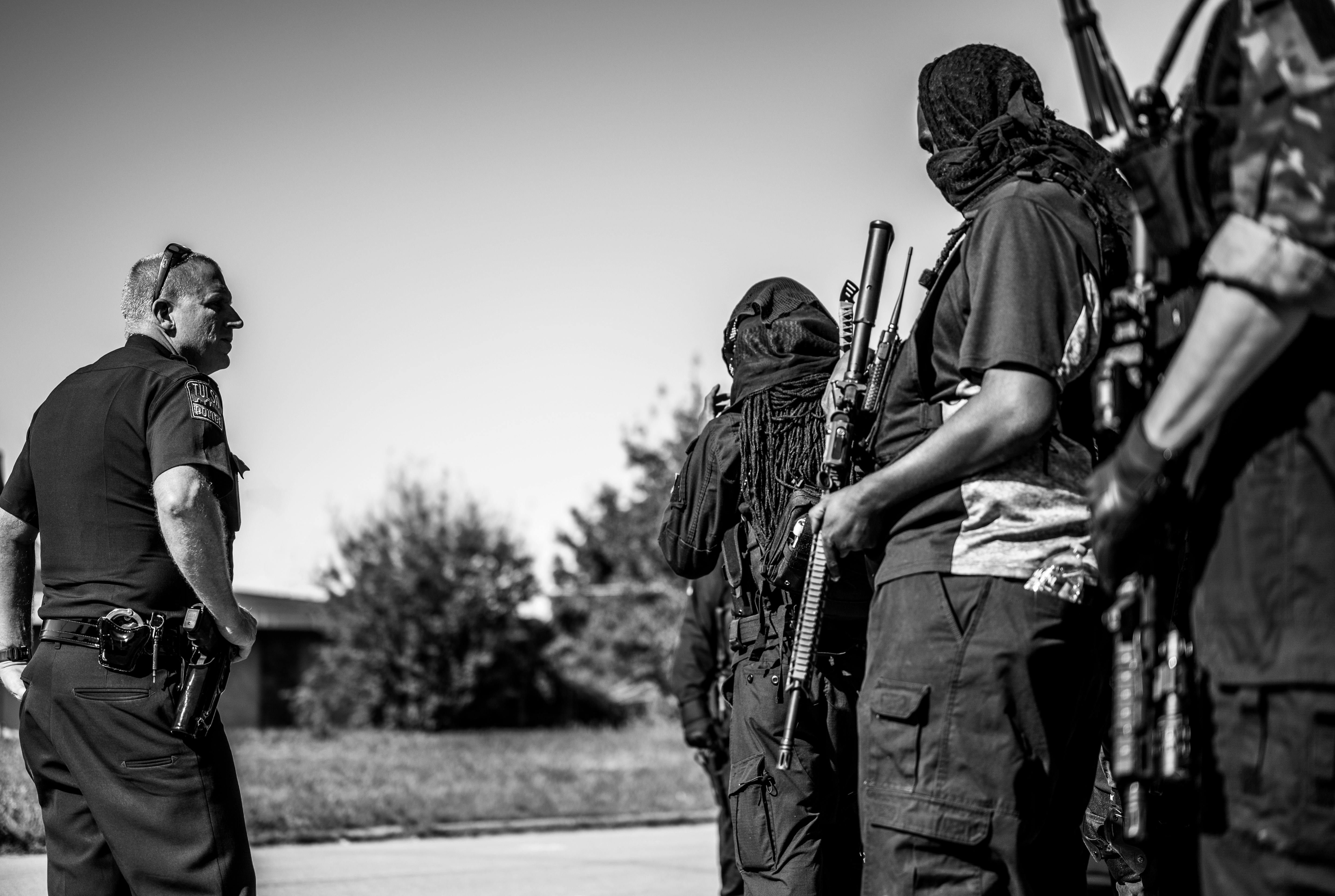 Grayscale Photo of Men with Guns · Free Stock Photo