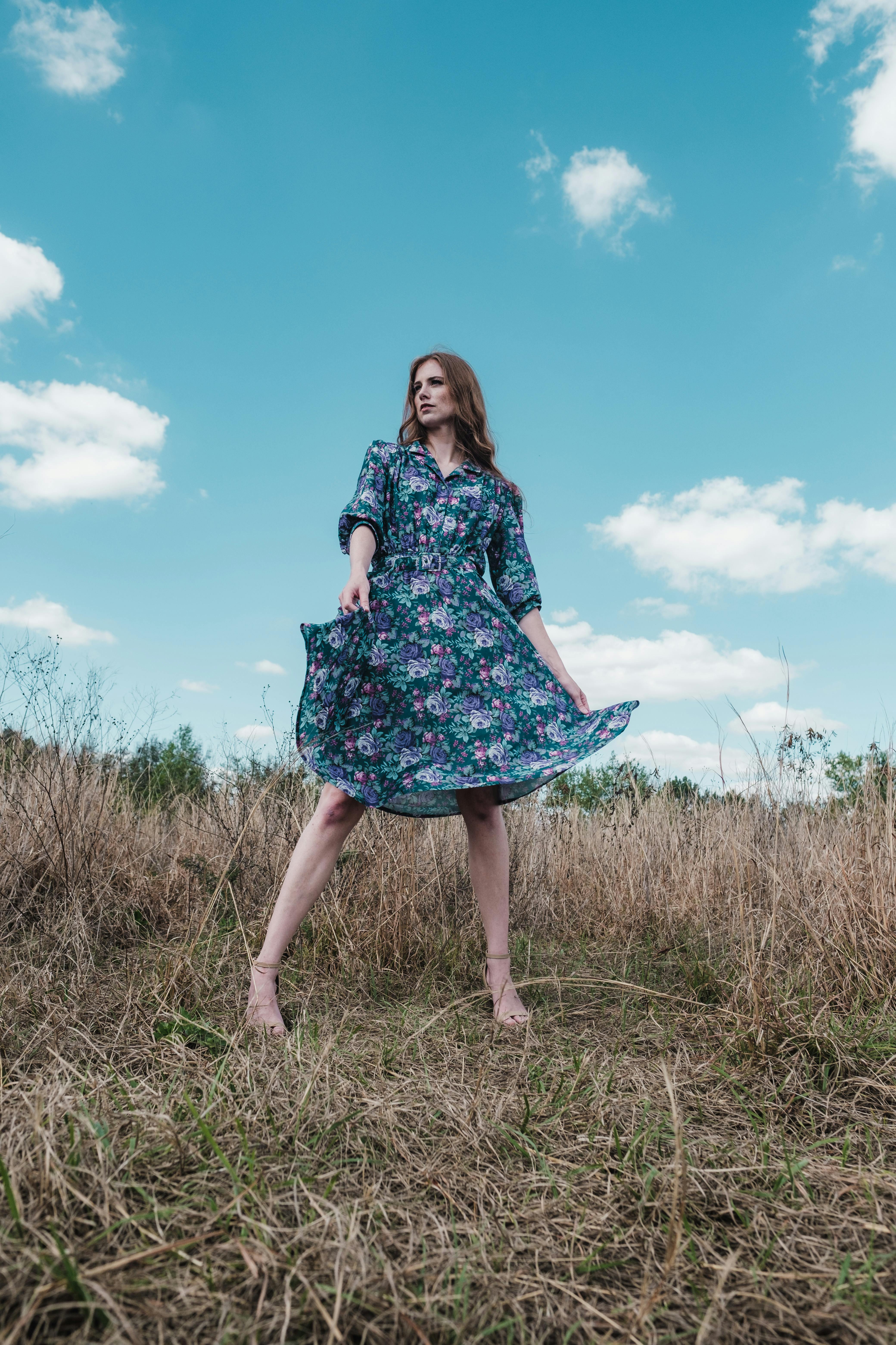 Low Angle Shot of Beautiful Woman in Floral Dress · Free Stock Photo