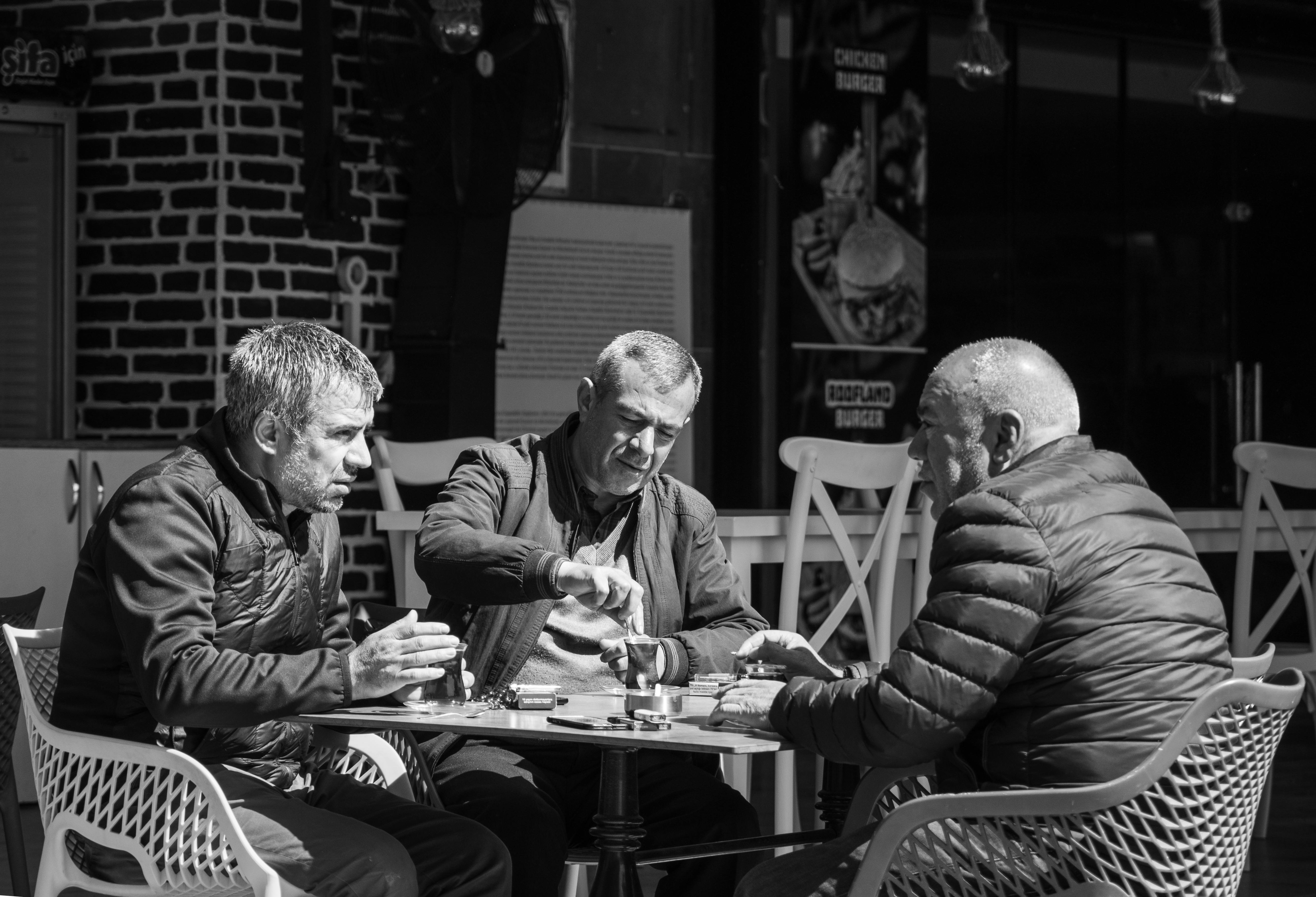 Photo of Two Men Talking While Sitting on Chair · Free Stock Photo