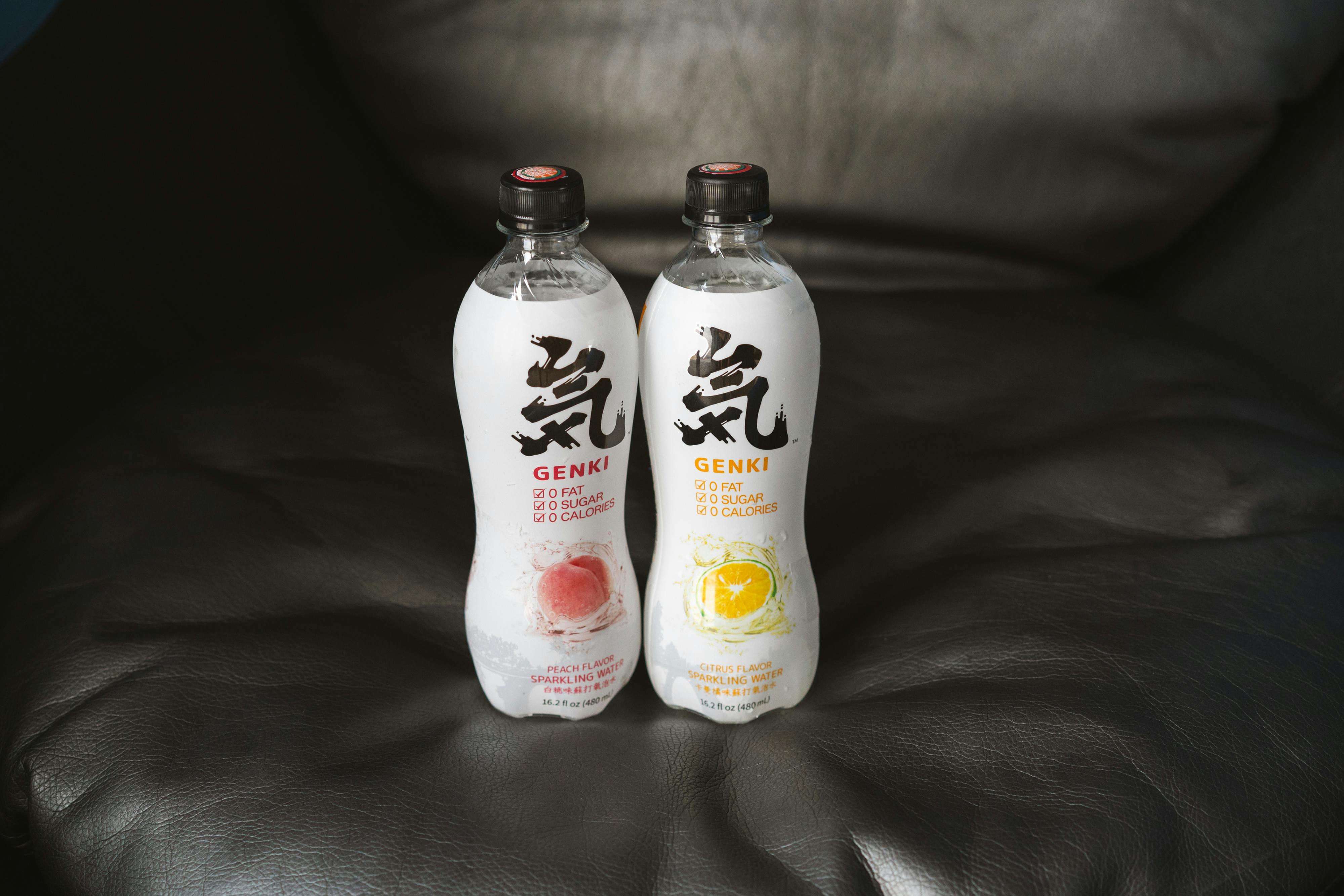Genki Sparkling Water Drinks on Leather Surface · Free Stock Photo