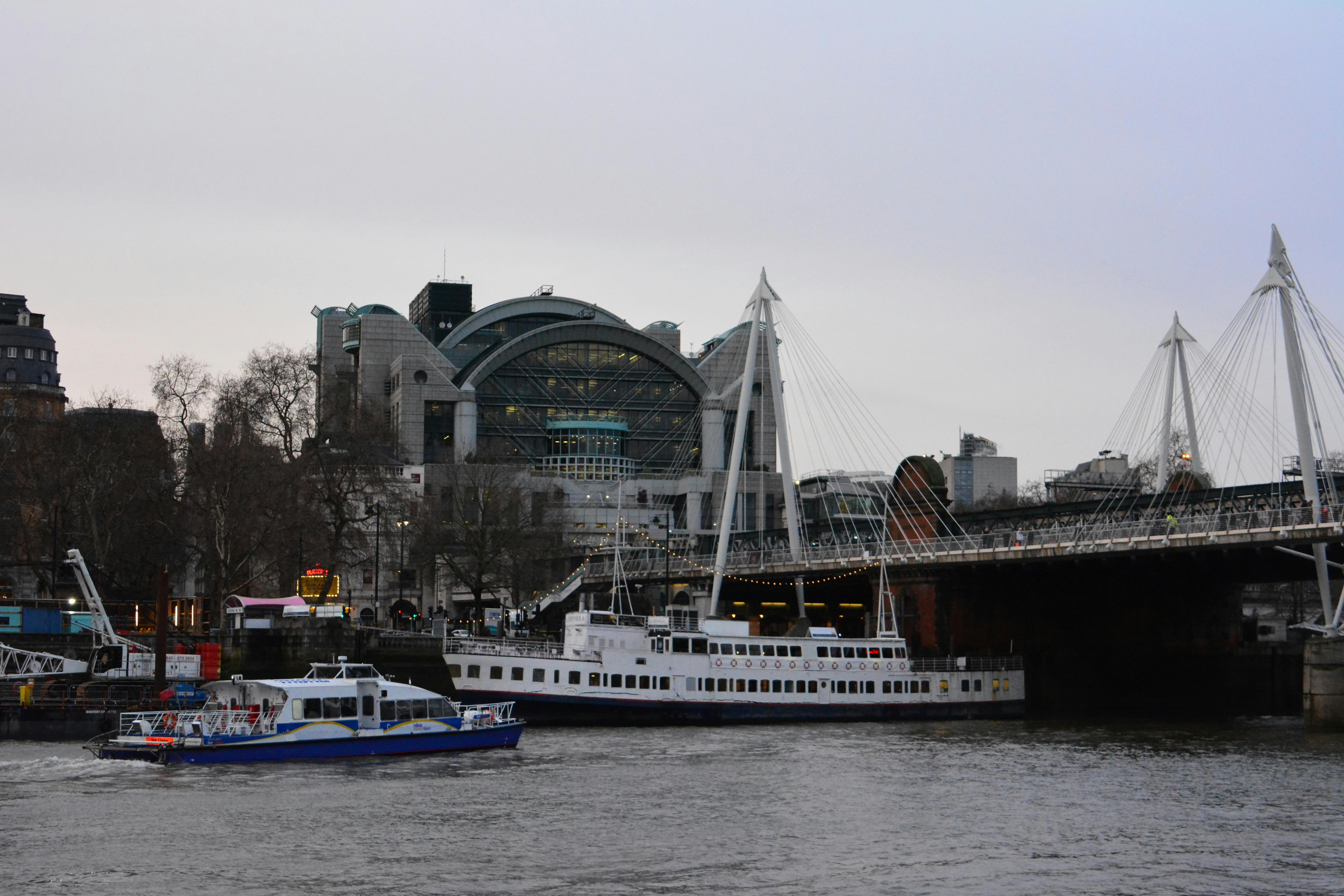 Boats by the Hungerford Bridge near the Charing Cross Station, London ...