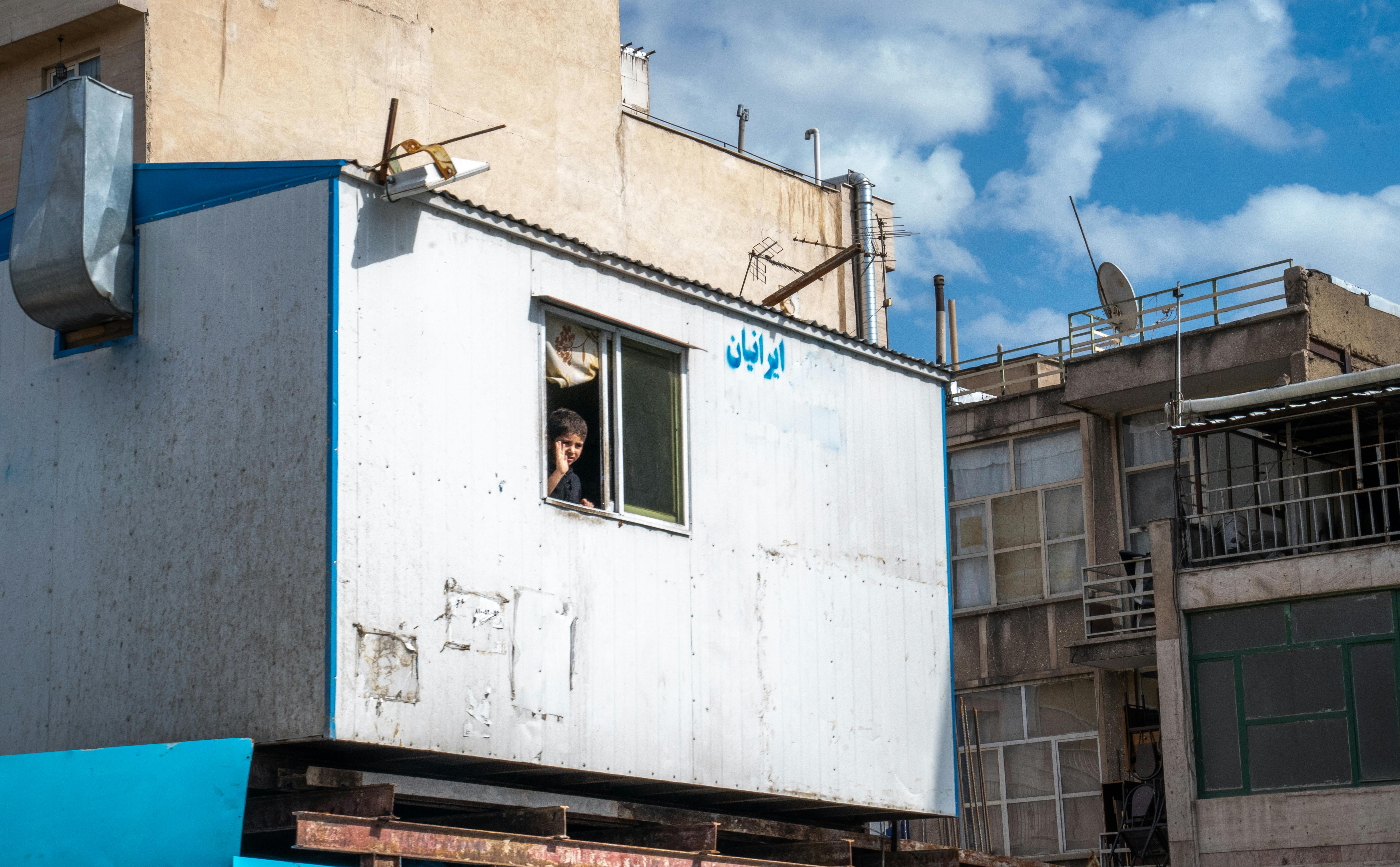 Young Boy Behind Open Window · Free Stock Photo