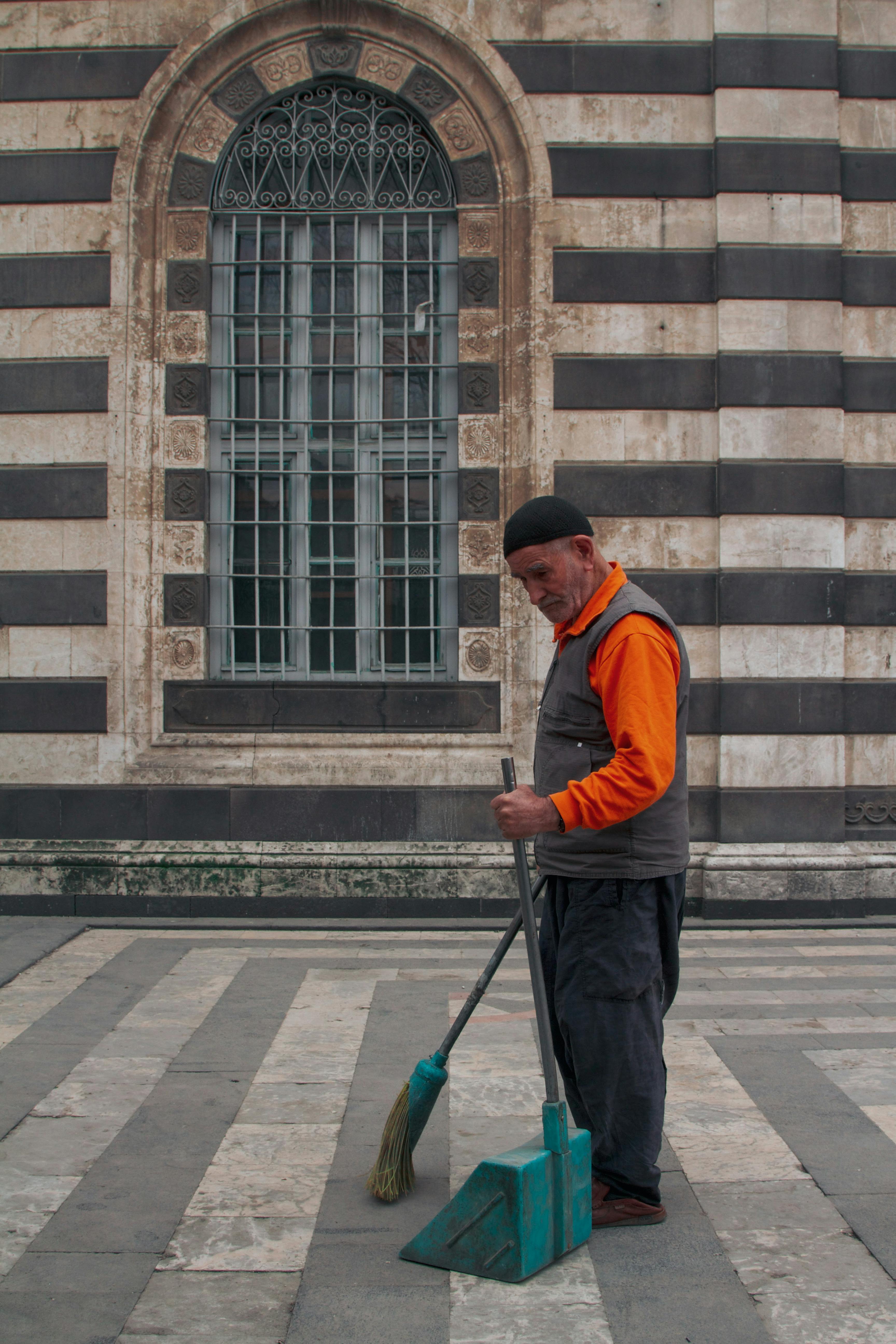 Cleaner Sweeping Sidewalk · Free Stock Photo