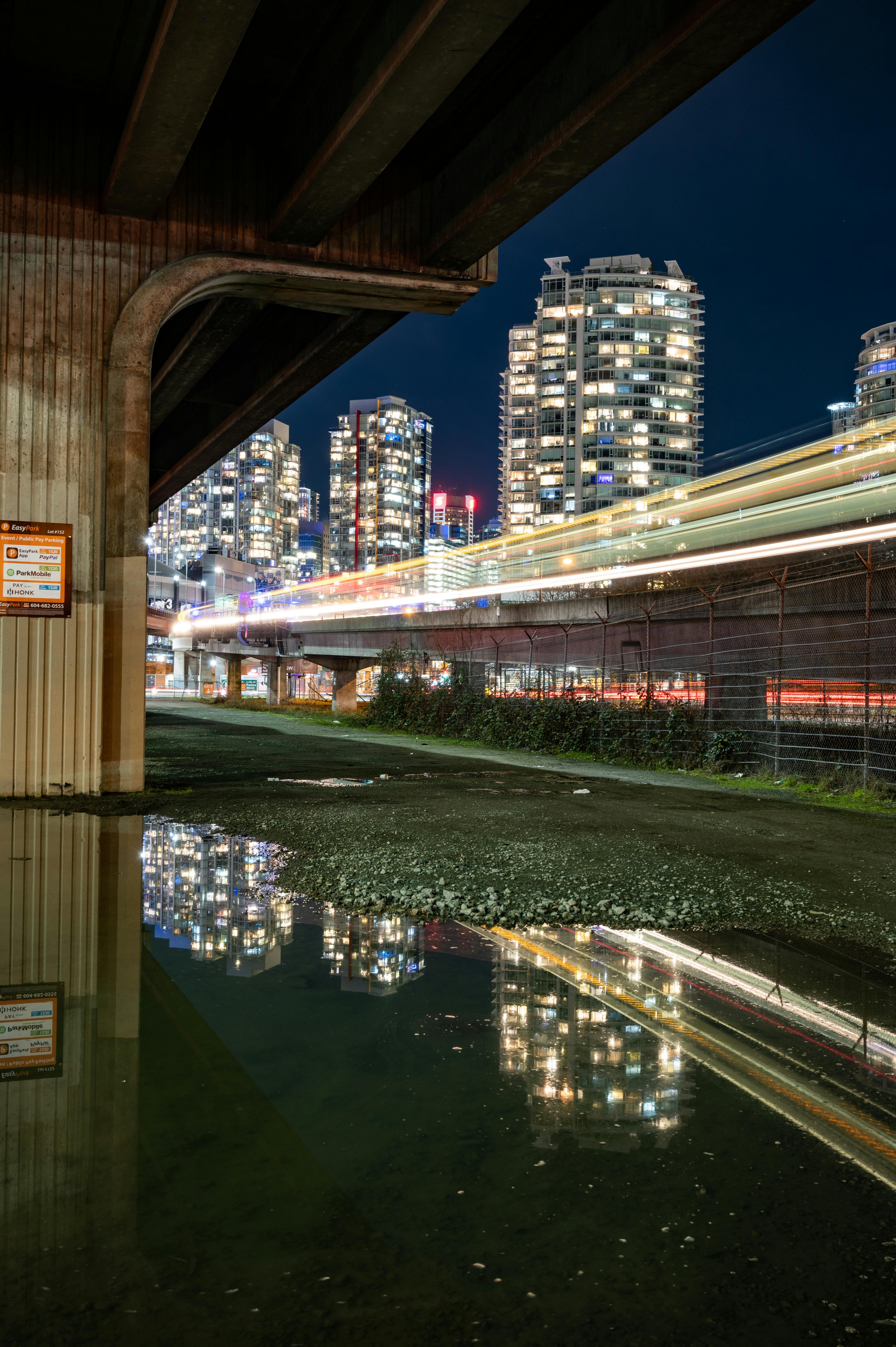 Gray Concrete Bridge Near City Buildings · Free Stock Photo