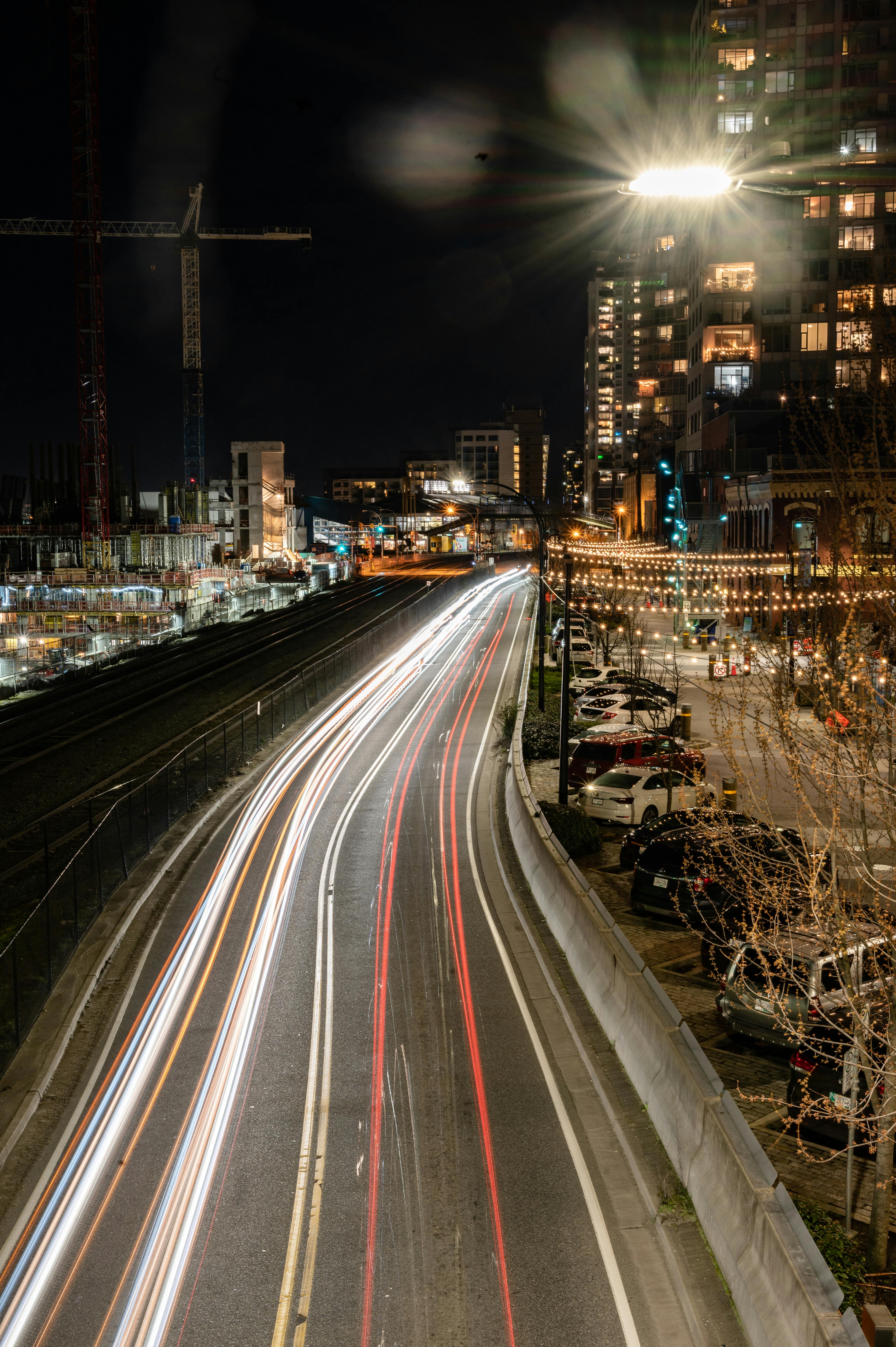 Construction Site Near Buildings during Night Time · Free Stock Photo