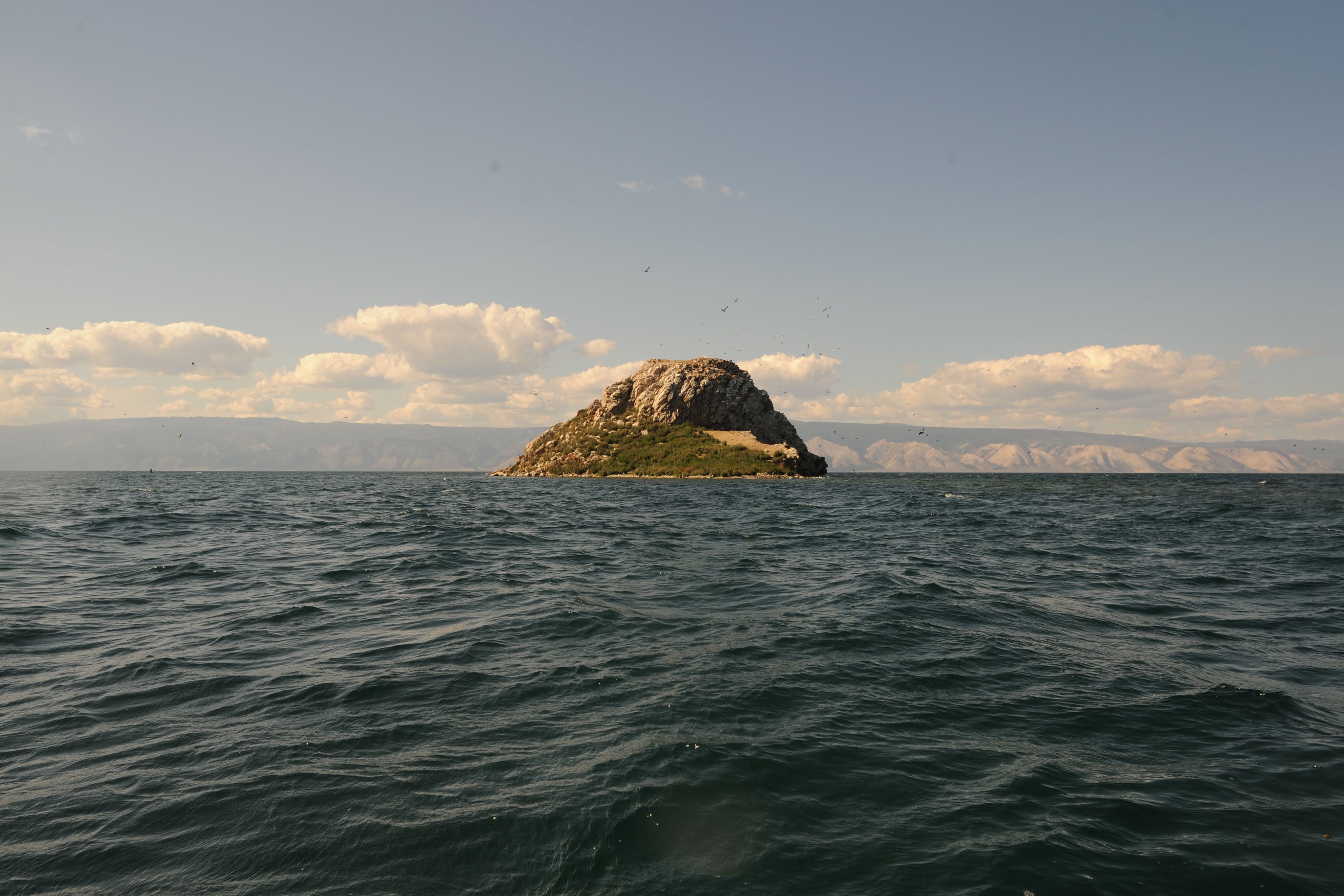 Rock Formation on an Island in the Sea · Free Stock Photo