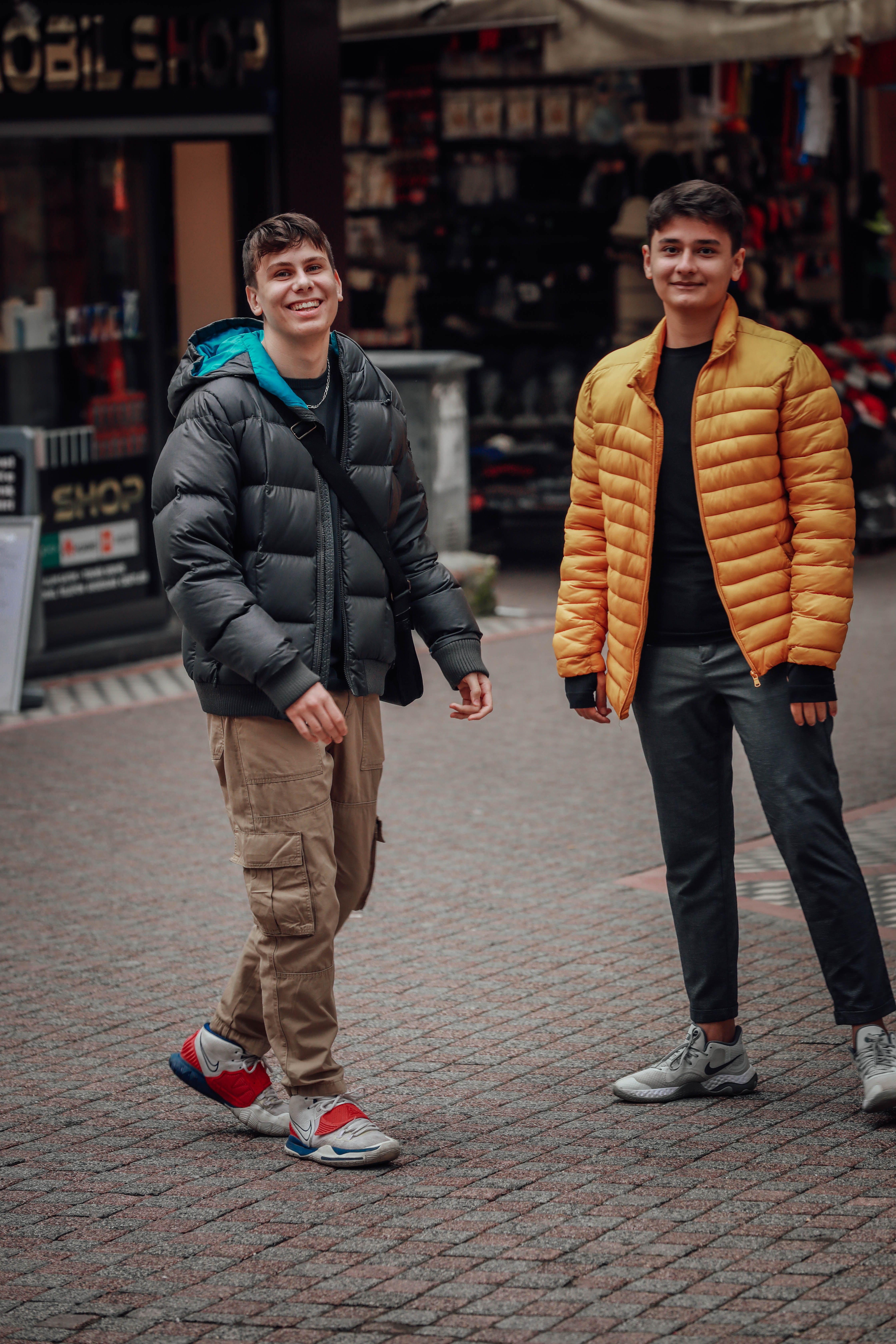Men Standing Beside Shopping Stalls · Free Stock Photo