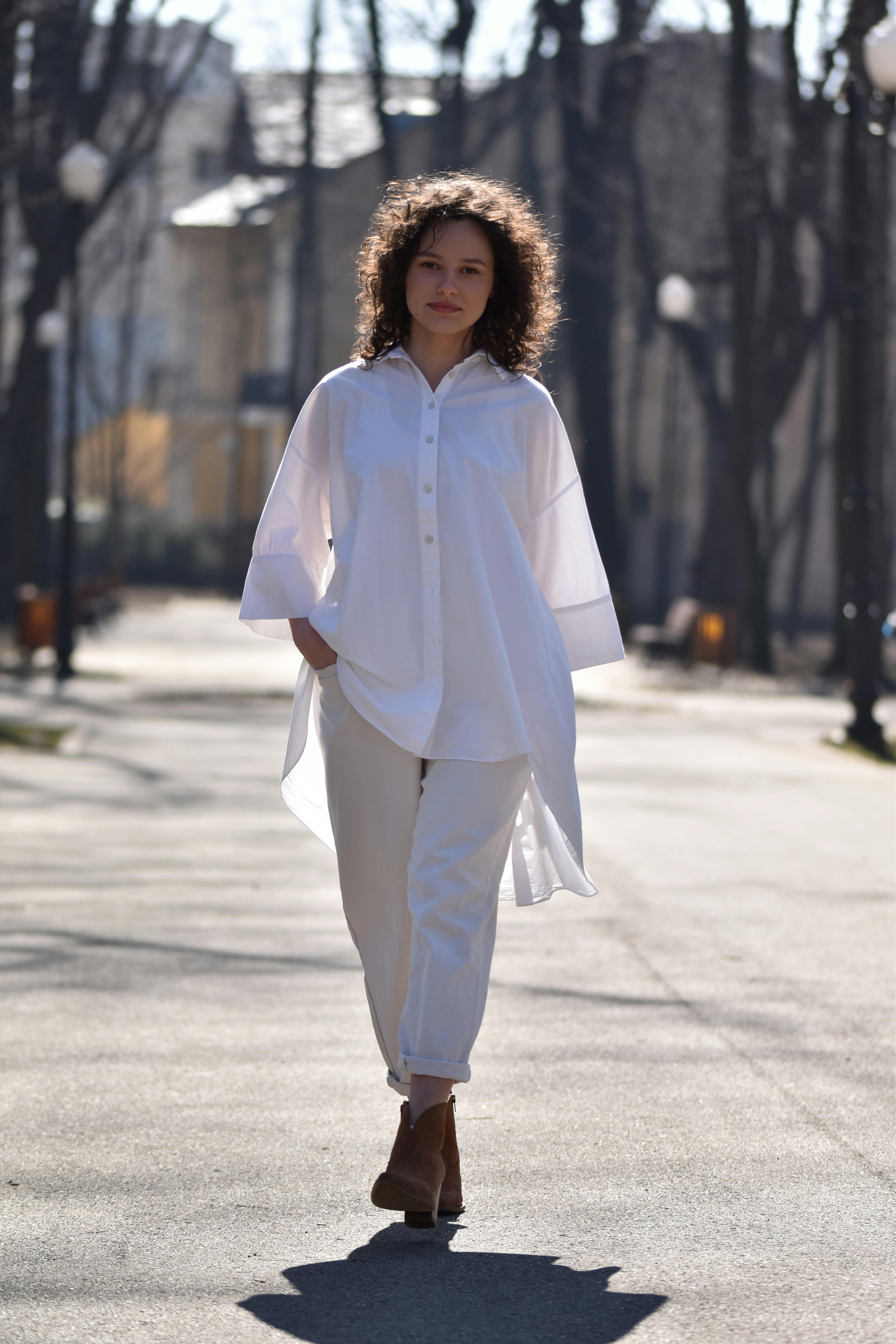 A Woman in White Clothing Walking · Free Stock Photo