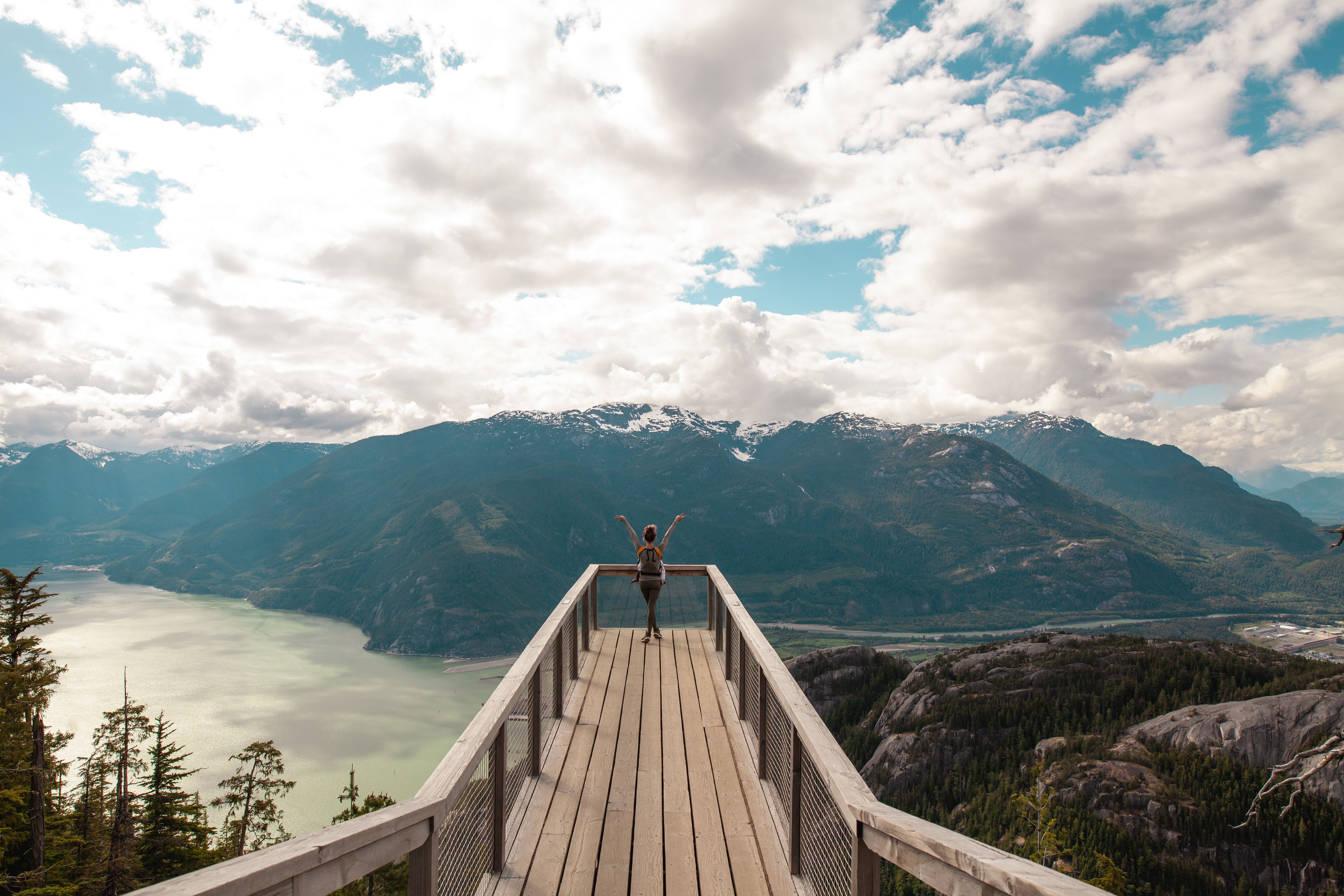 Person in Wooden Balcony Overlooking Mountains · Free Stock Photo
