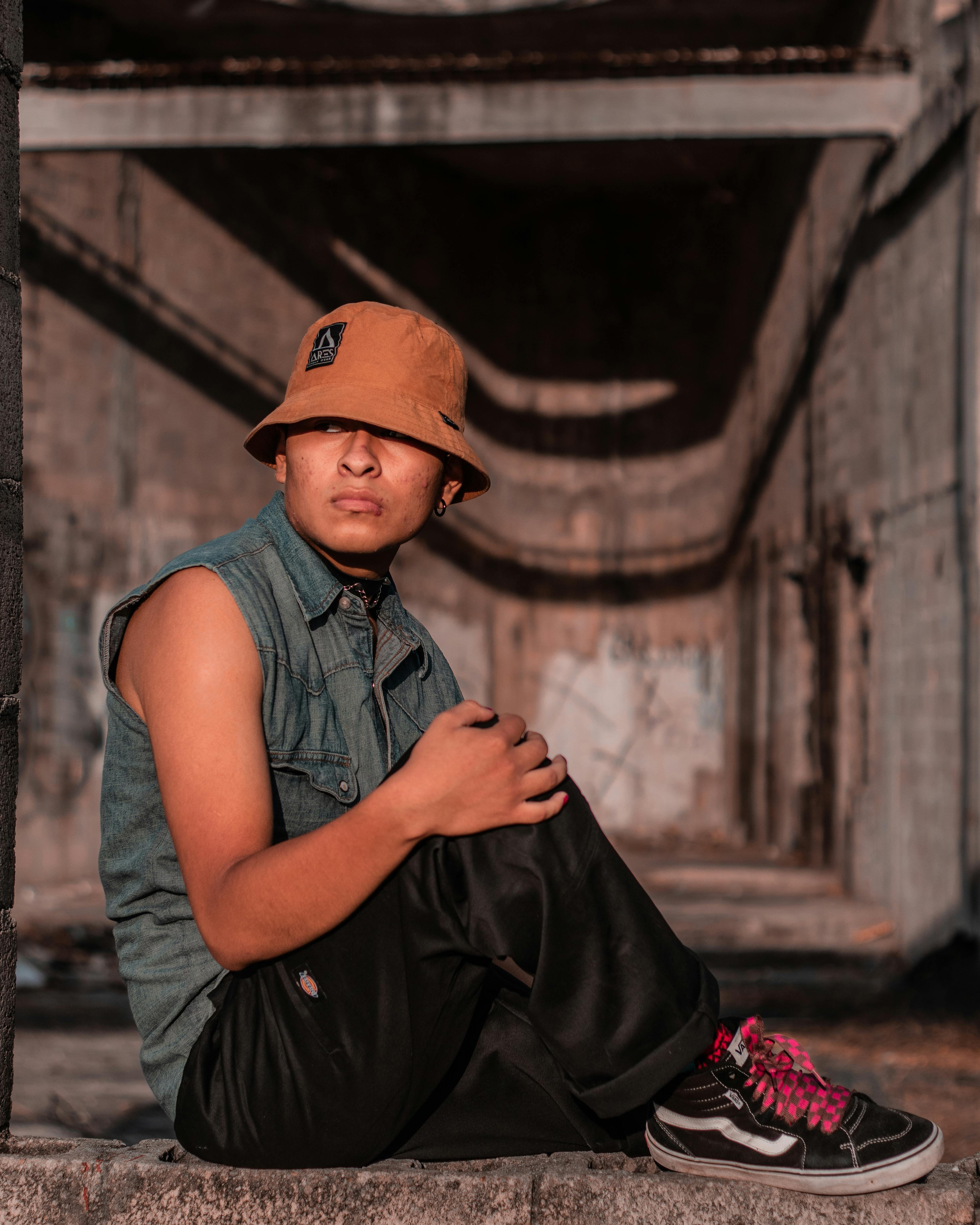 Photo of a Man with a Blue Bucket Hat Covering His Face · Free Stock Photo