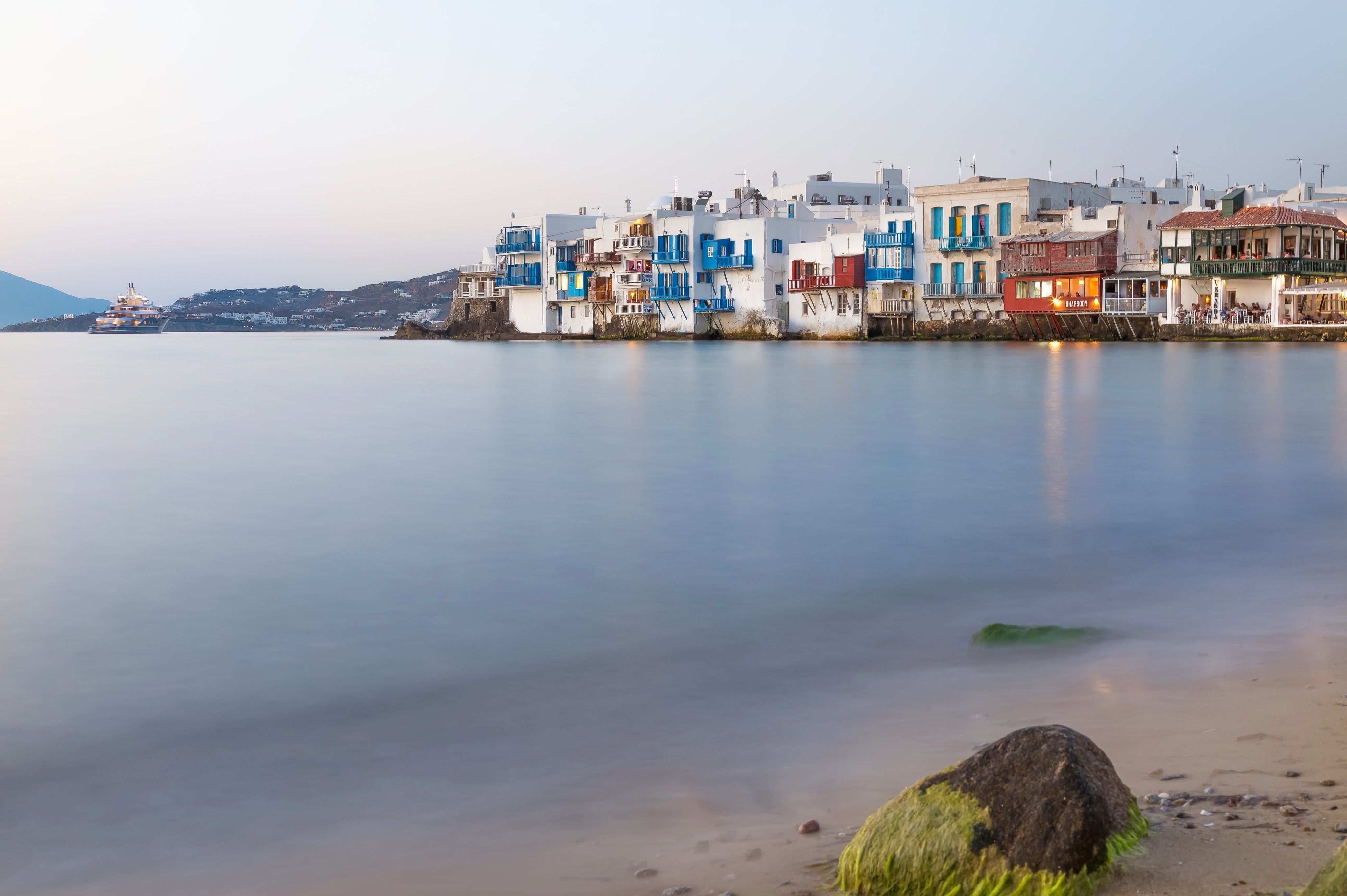 Photo Of White Concrete Buildings Near Body Of Water · Free Stock Photo