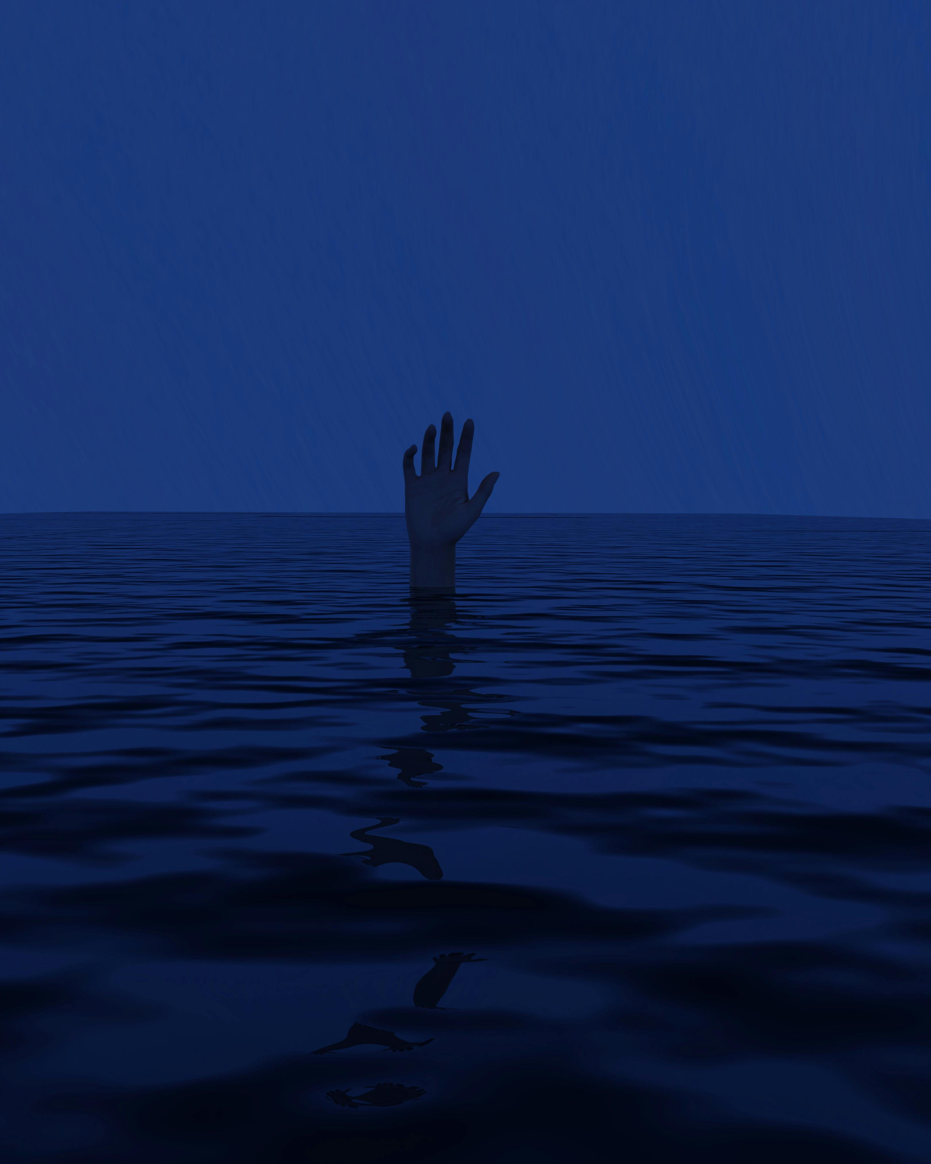 A Human Hand Off The Water's Surface · Free Stock Photo