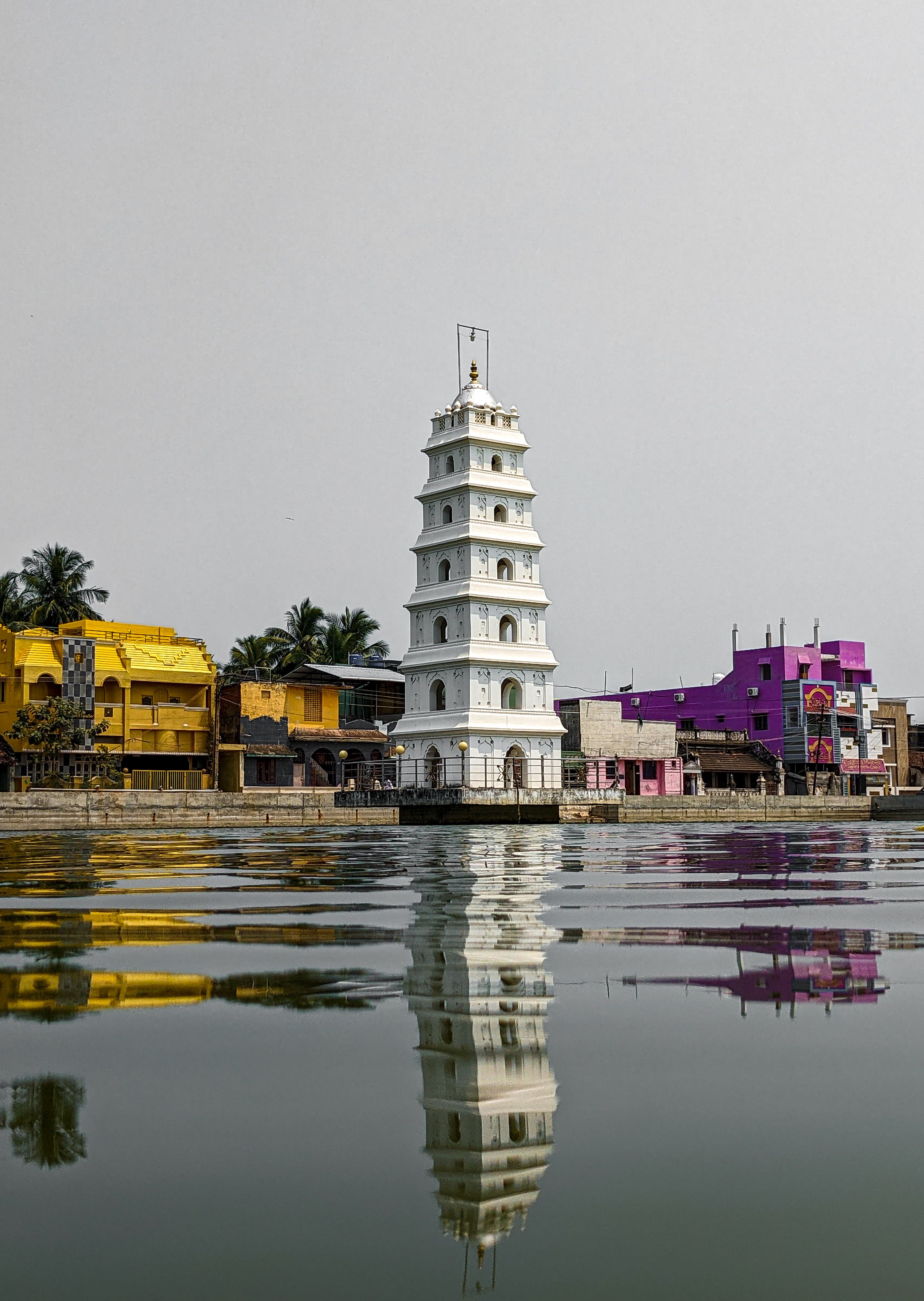 Brown and Green Temple Near Body of Water Under Blue Sky · Free Stock Photo