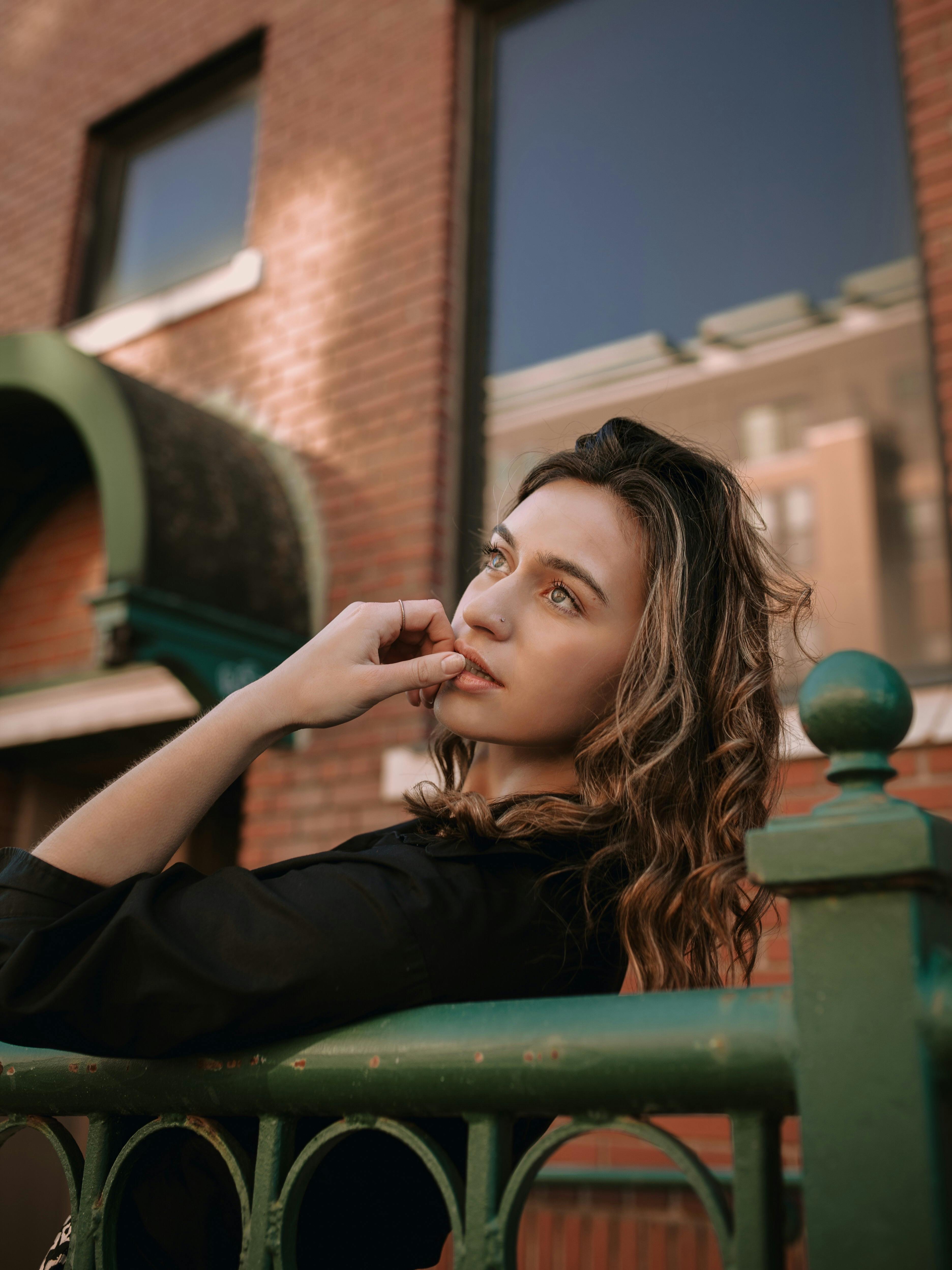 A Woman Leaning on the Railing · Free Stock Photo
