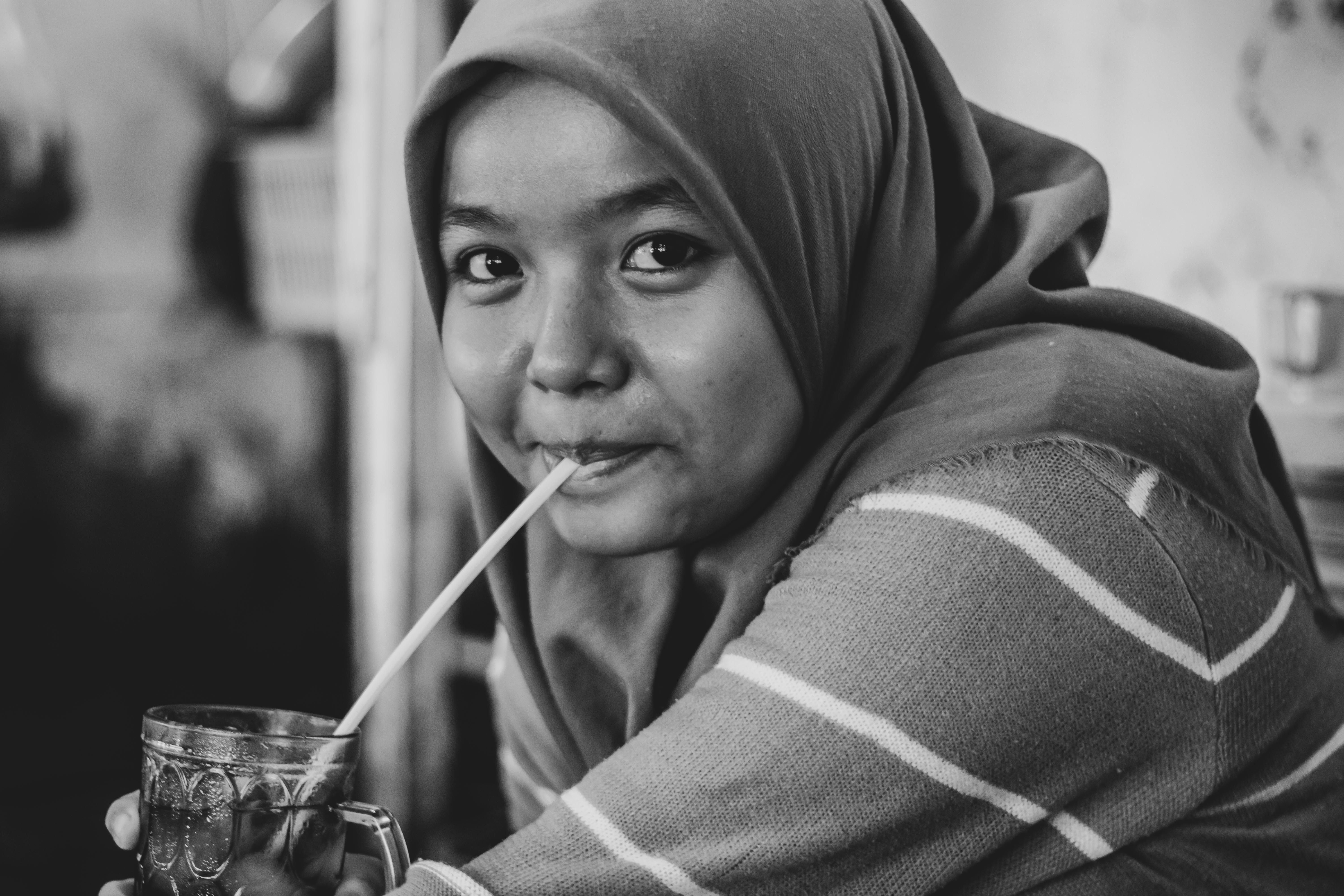Woman Sipping from a Straw · Free Stock Photo