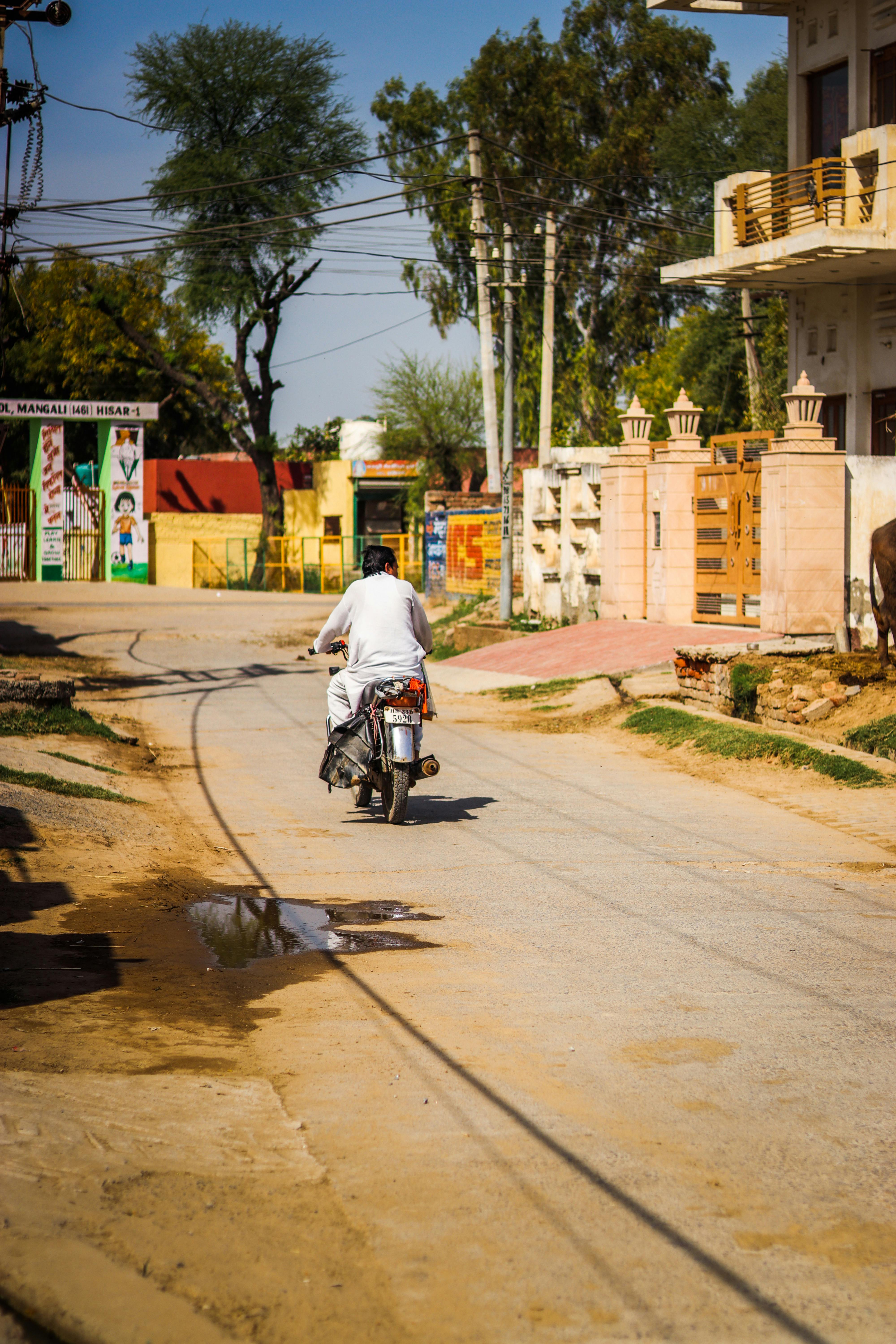 Man Riding Motorbike in Village · Free Stock Photo