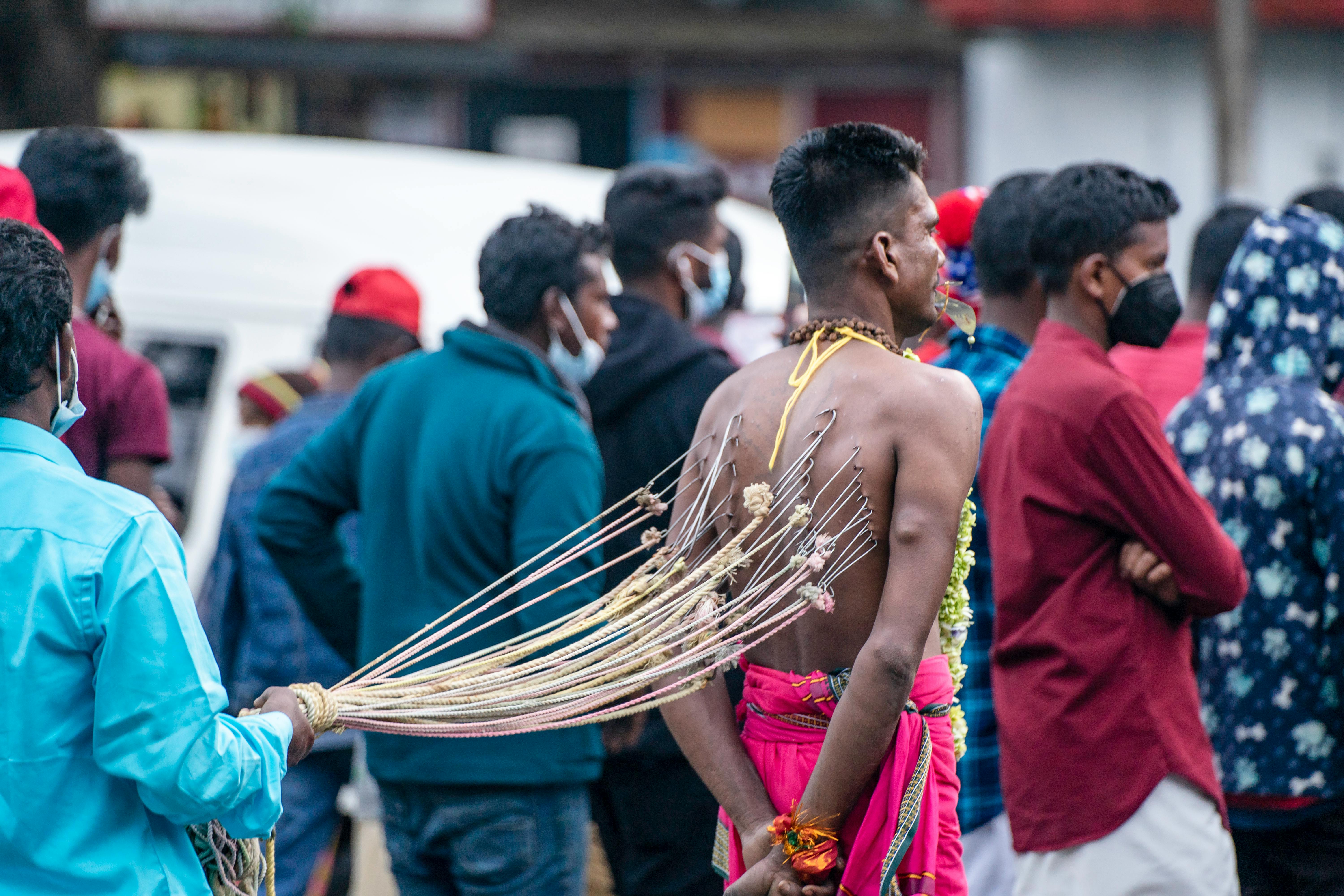 A Man with Hooks in his Back · Free Stock Photo