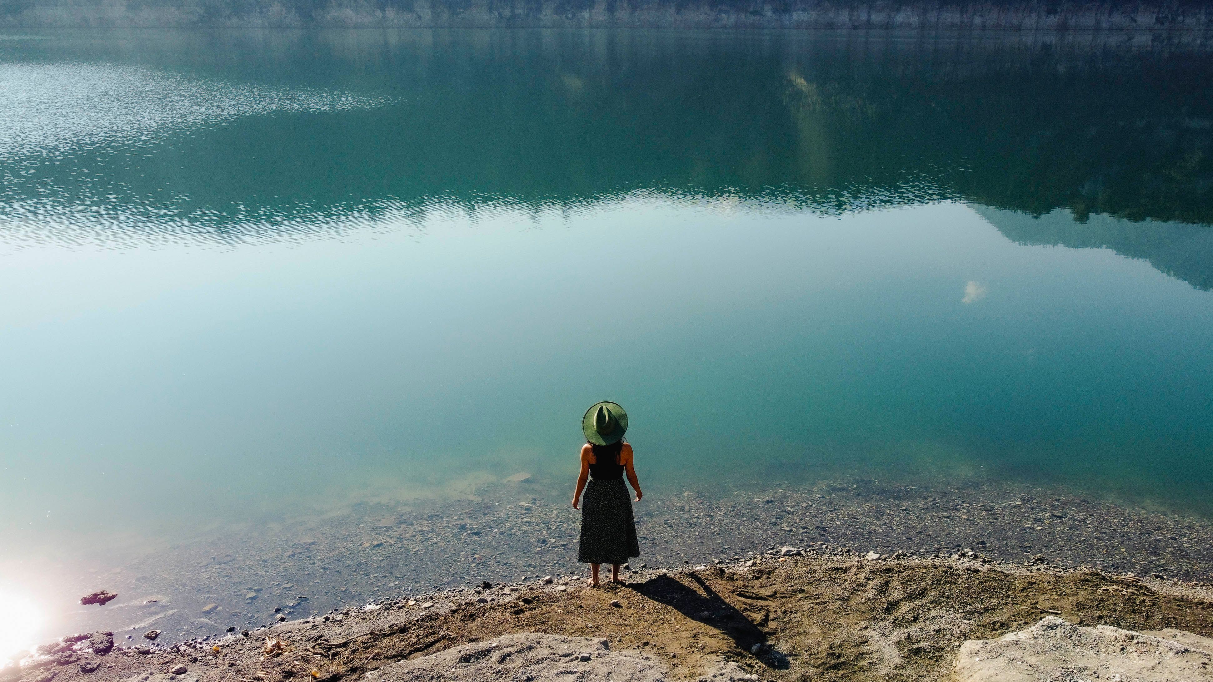 Person Standing on a Brown Wood Log Floating on a Body of Water · Free ...