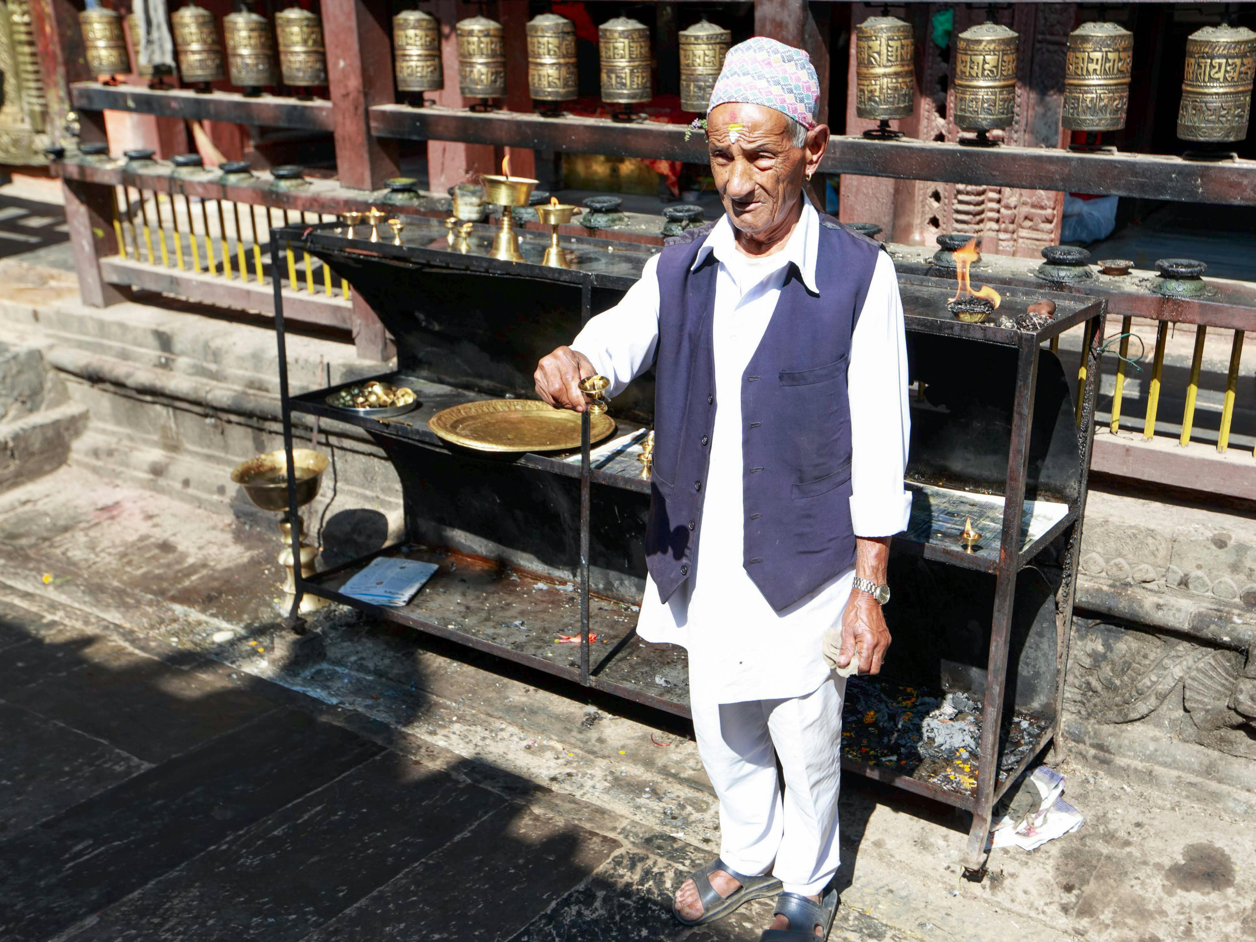 A Man Standing by a Market Stall · Free Stock Photo