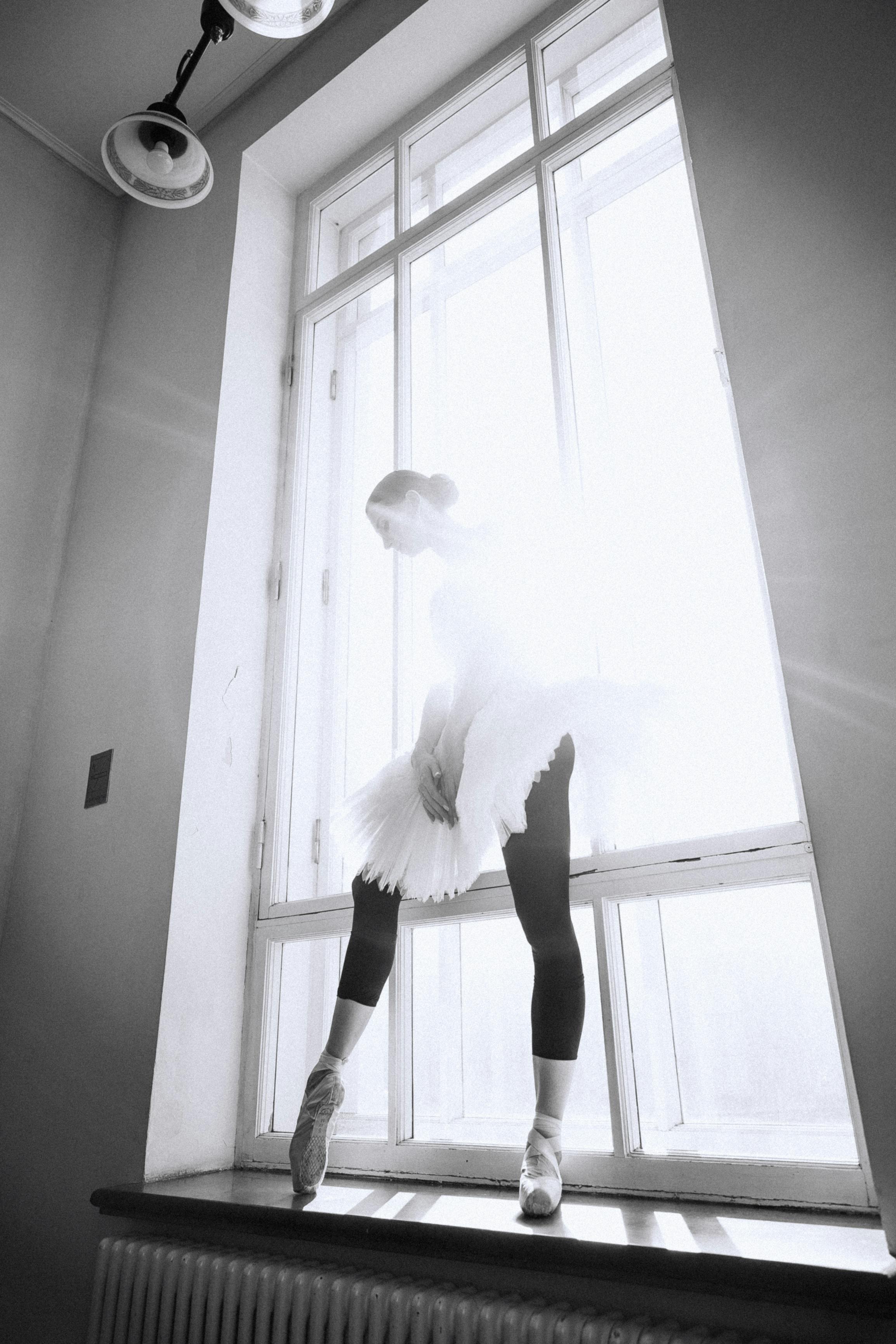 Grayscale Photo of a Ballerina Standing Near the Glass Window · Free ...