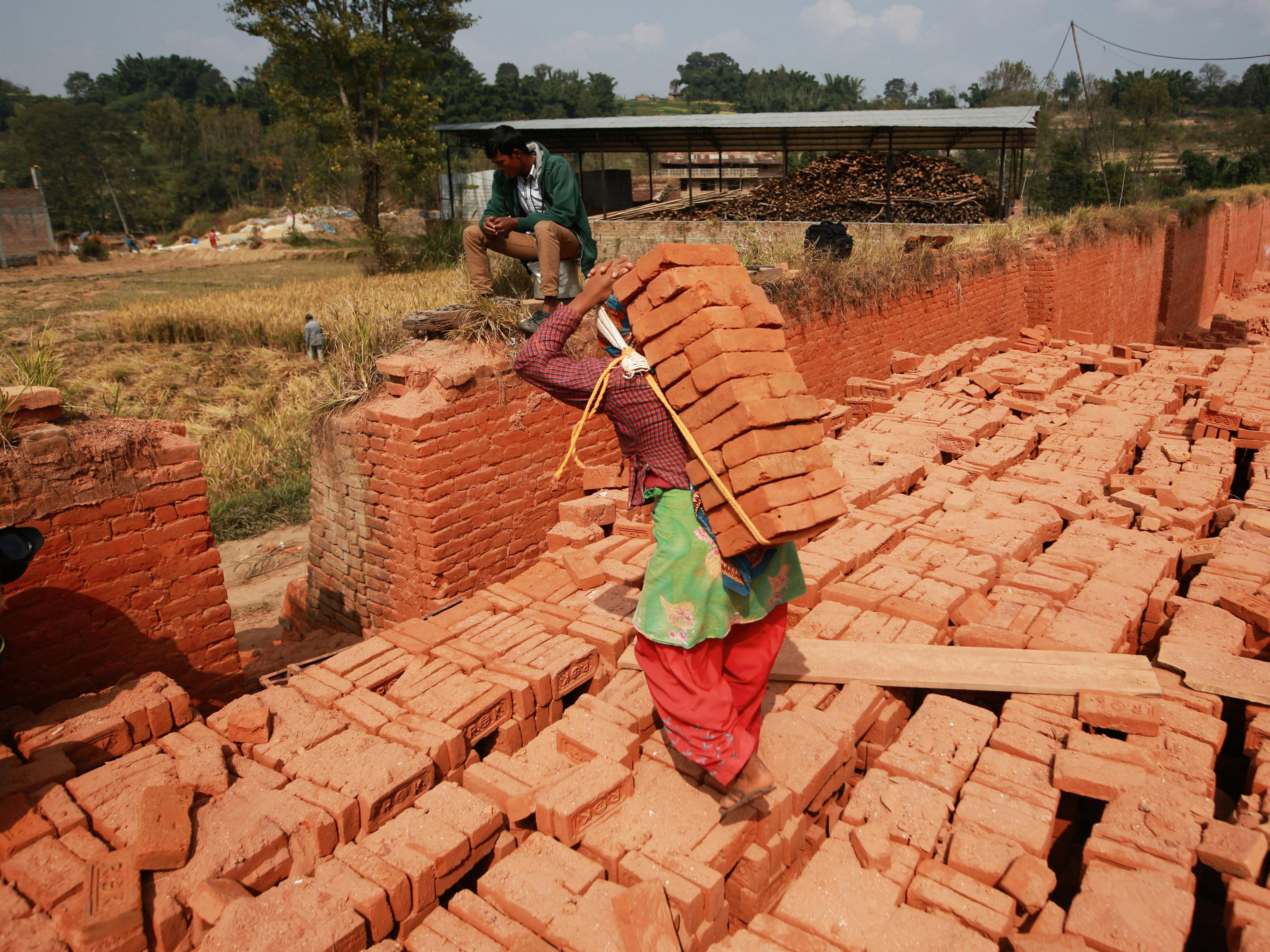 Person carrying a Stack of Bricks · Free Stock Photo