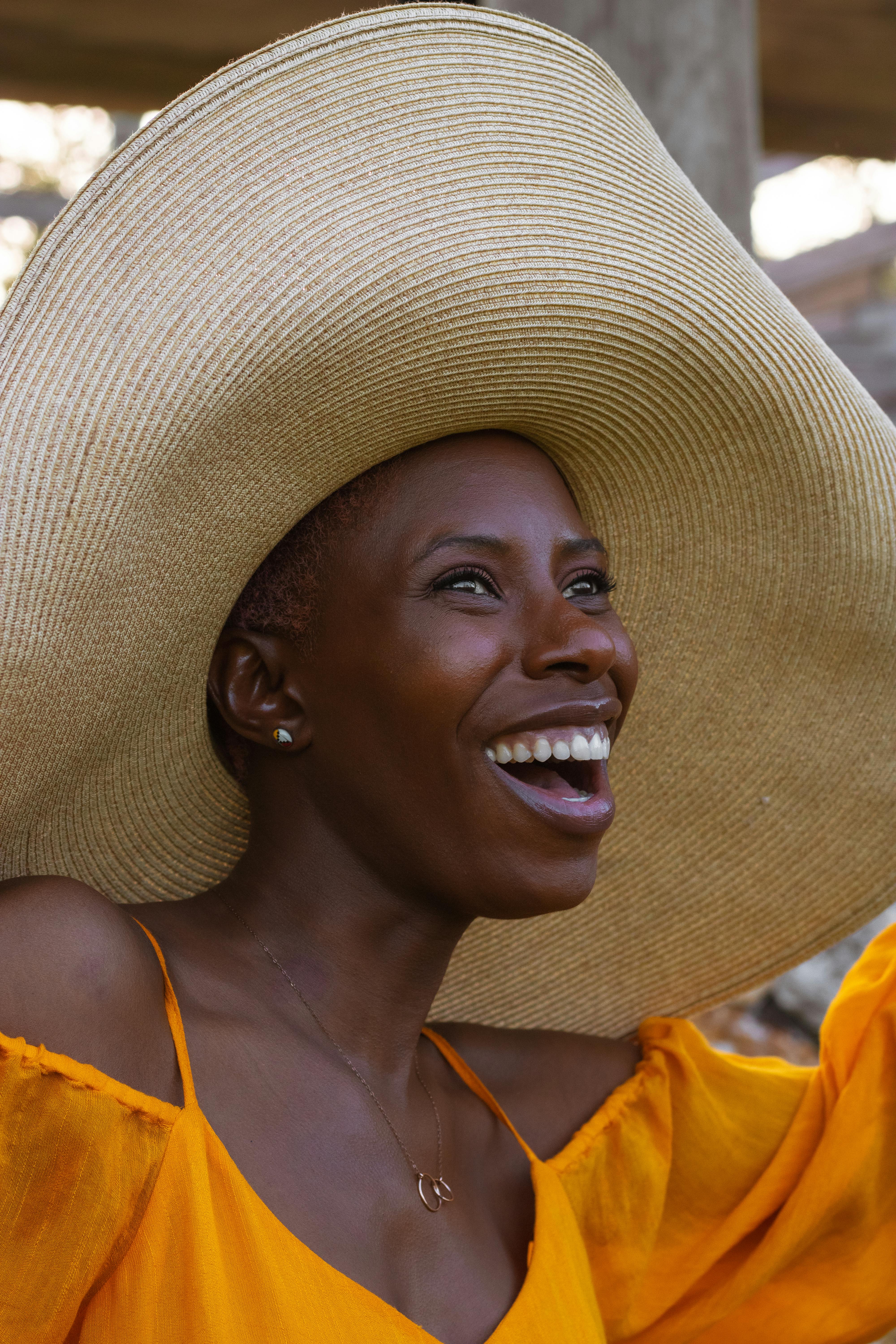 Woman in Big Round Hat Smiling · Free Stock Photo