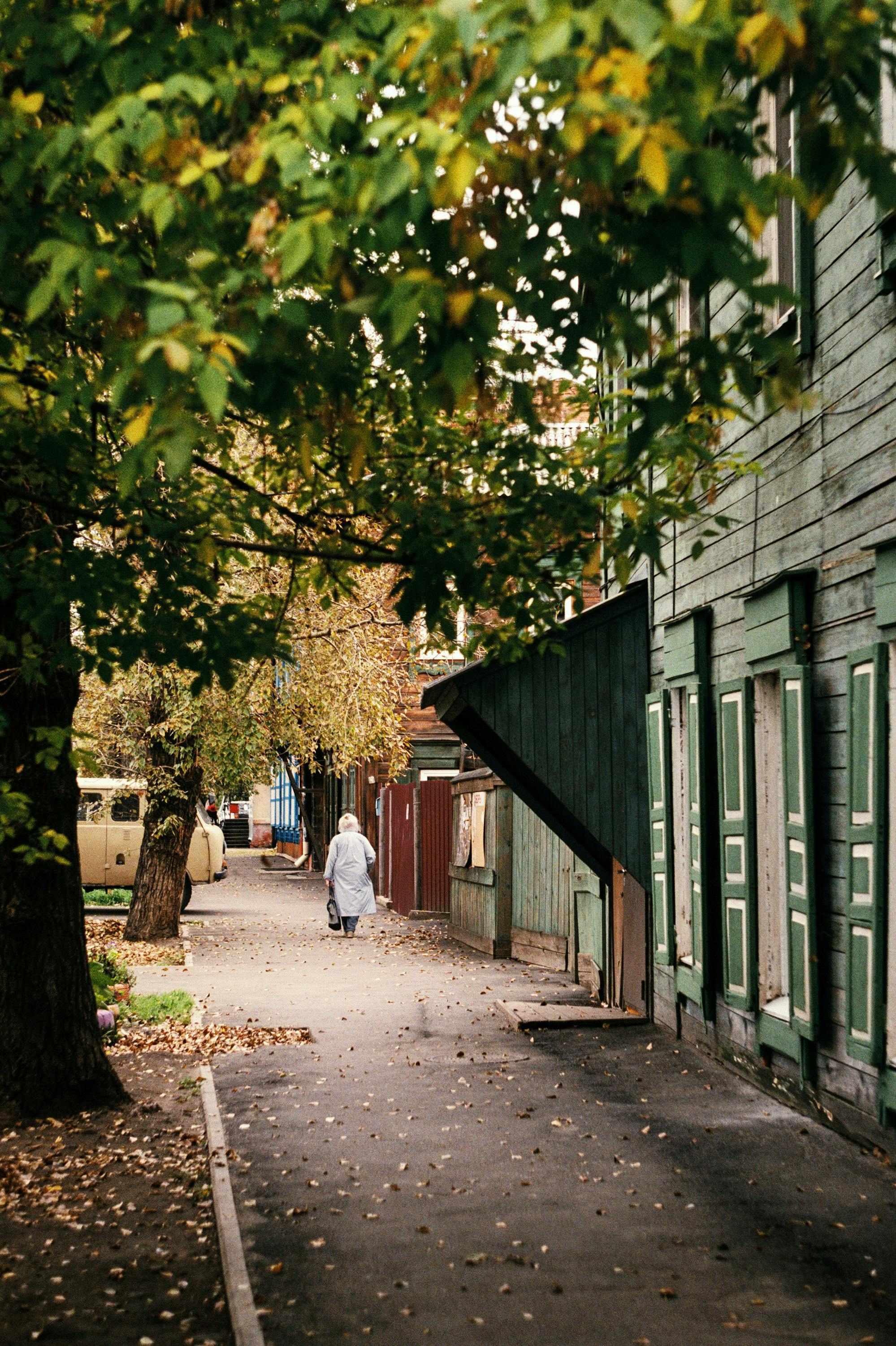 A Woman Walking on Sidewalk · Free Stock Photo