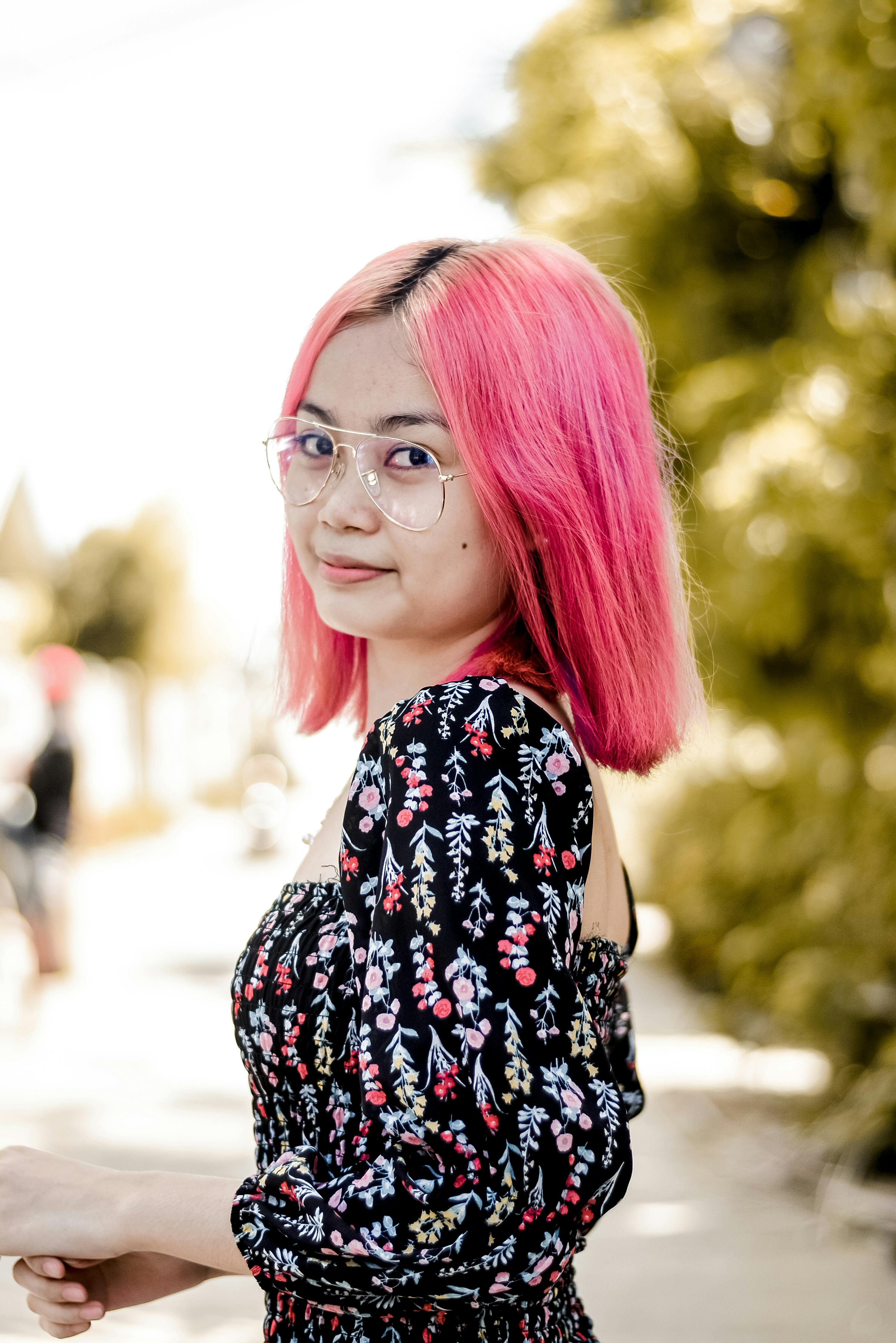 Cute Pink Haired Woman Posing by Wall · Free Stock Photo