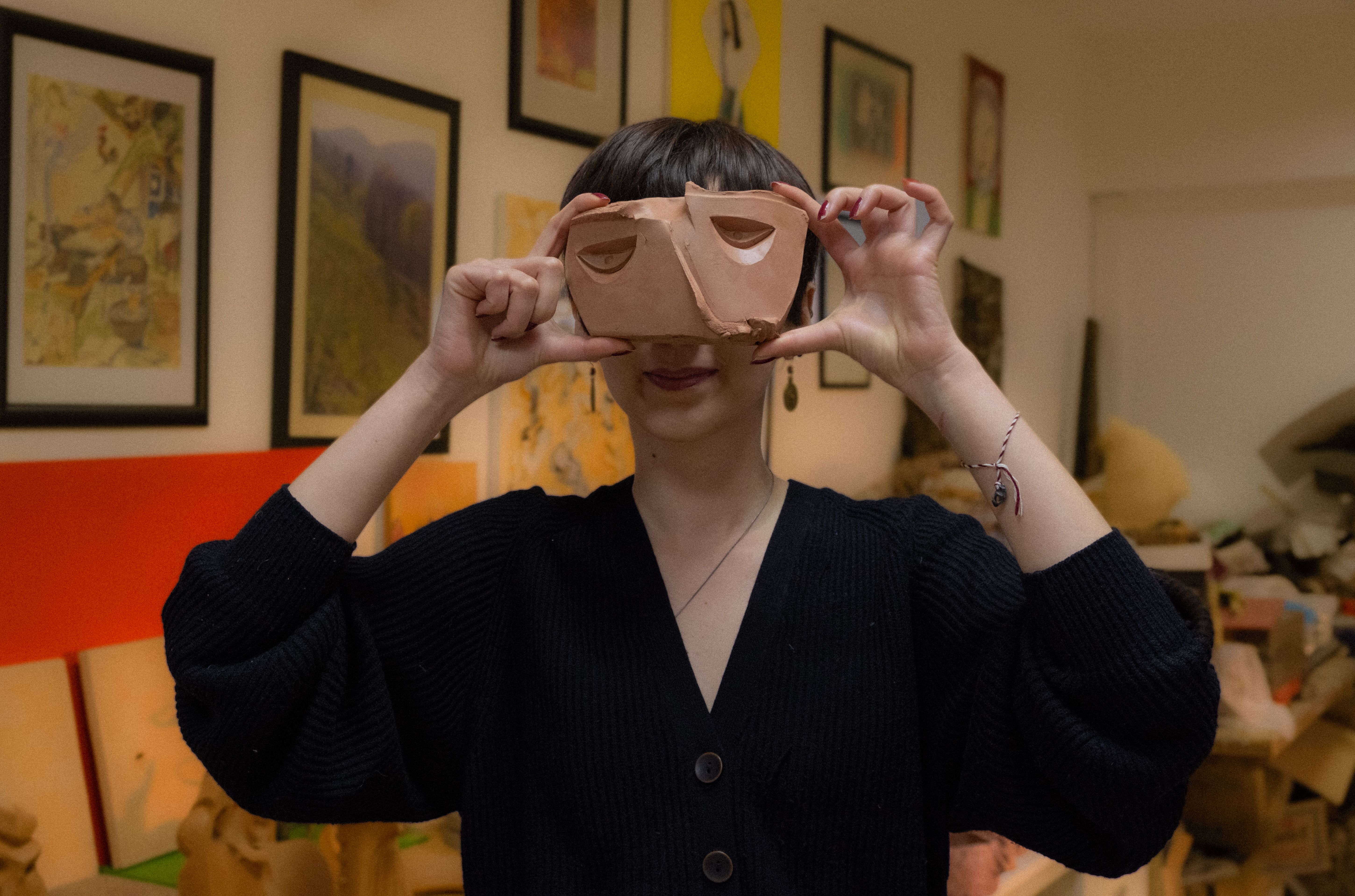 A Person in Black Sweater Holding a Mask on Face · Free Stock Photo