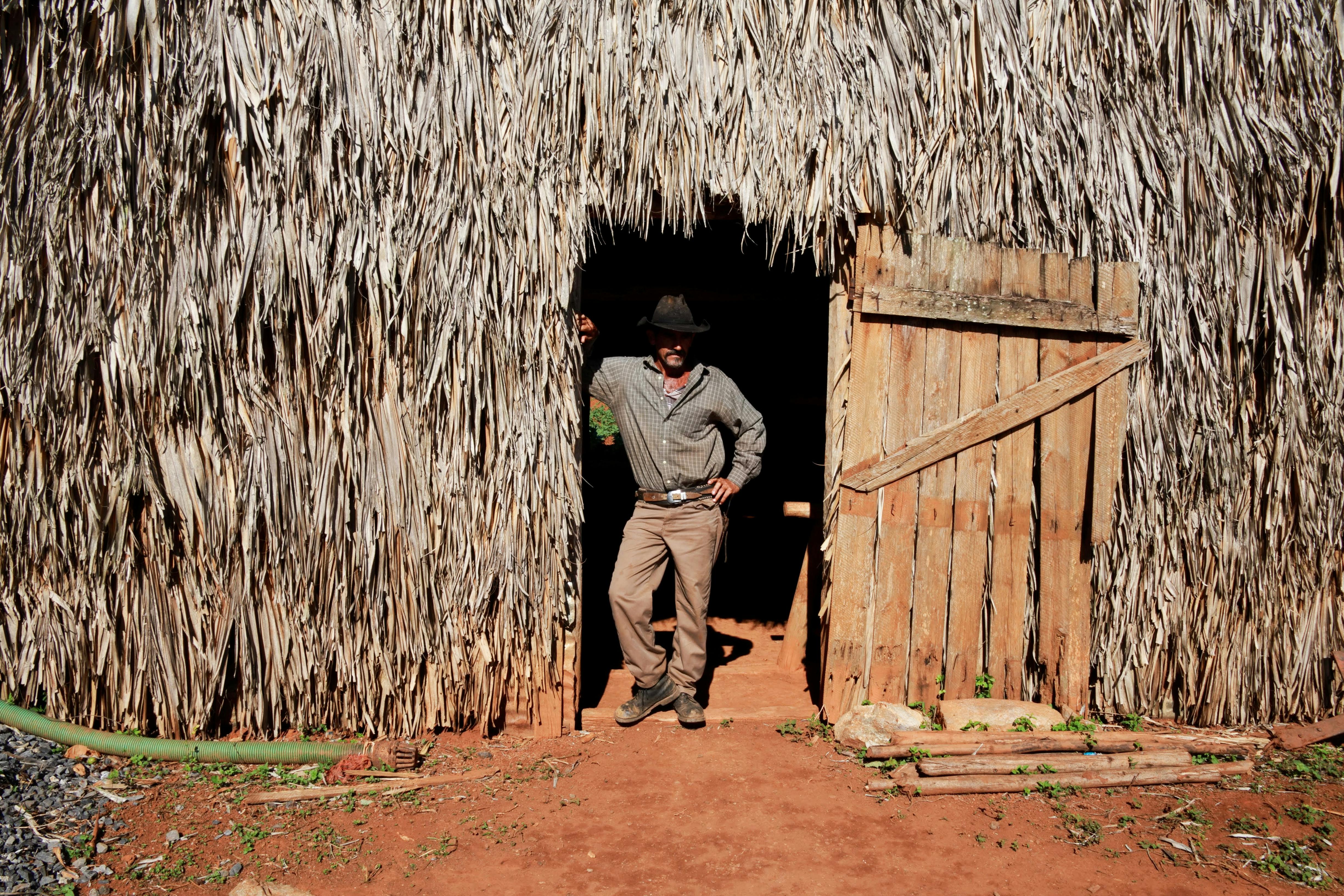 Cowboy Standing on a Doorway in a Wooden Shelter · Free Stock Photo